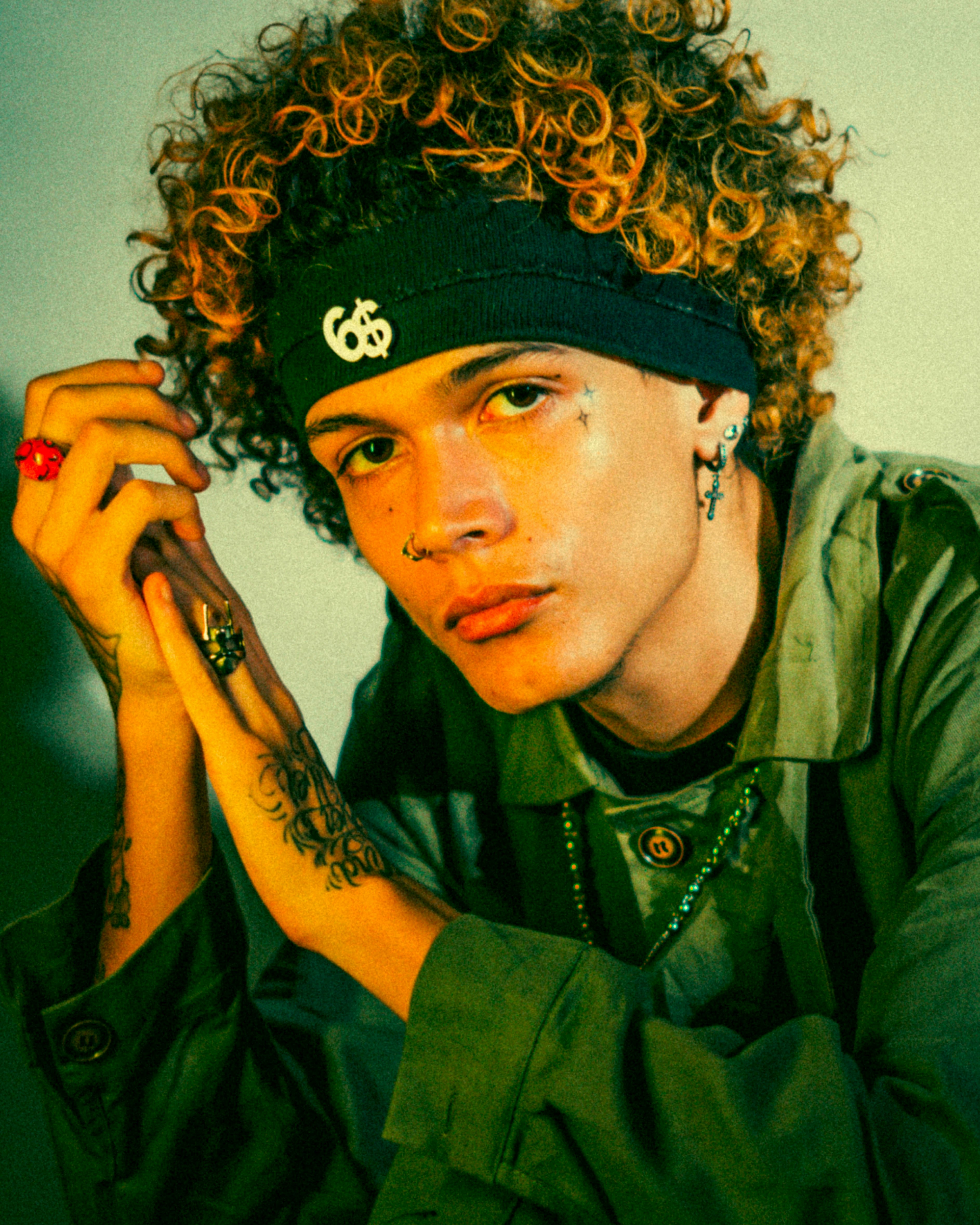 Neon-Tinted Portrait: Curly-Haired Rebel in a Black Headband
