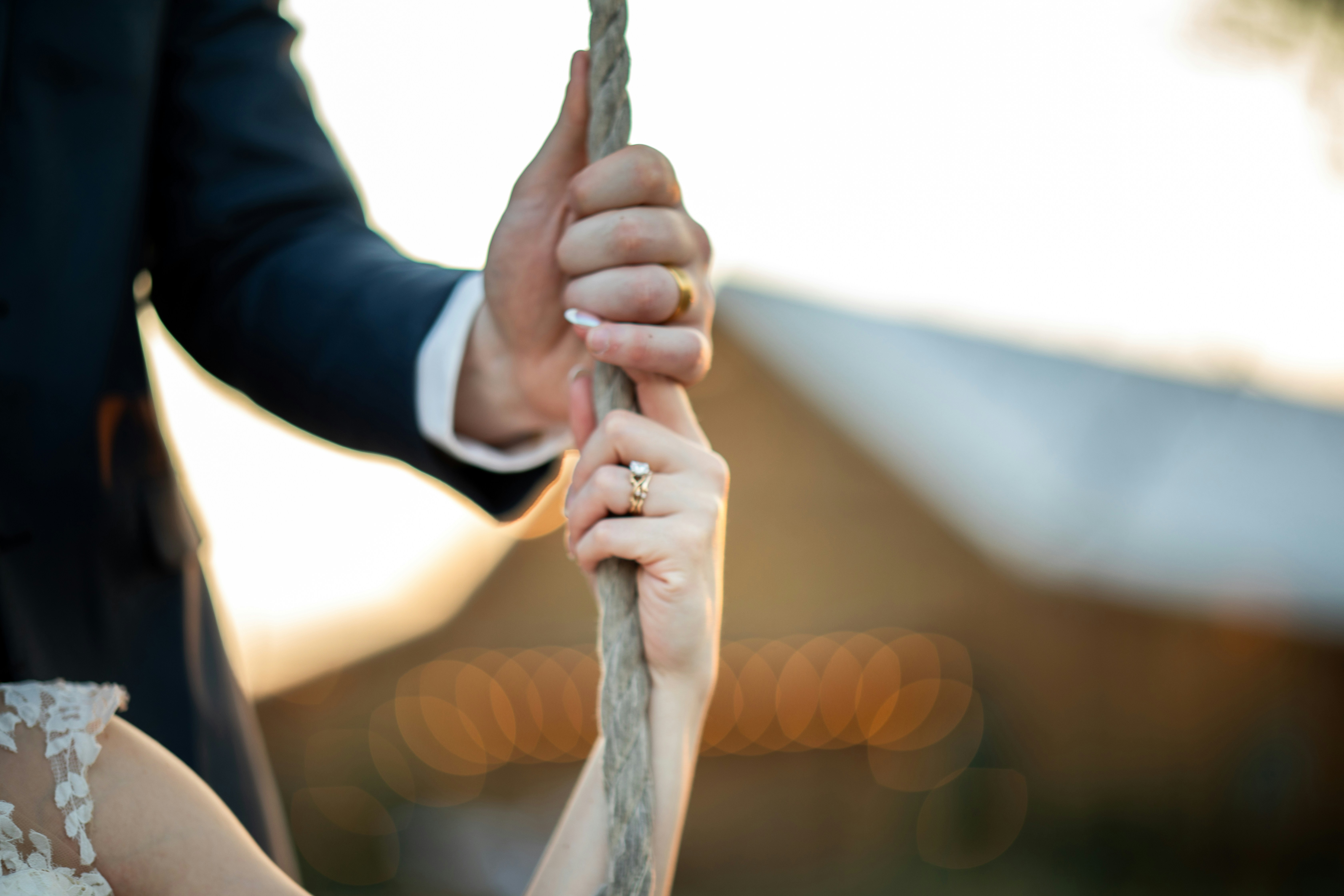 Golden Hour Ring Grip: A Wedding Moment on a Rope