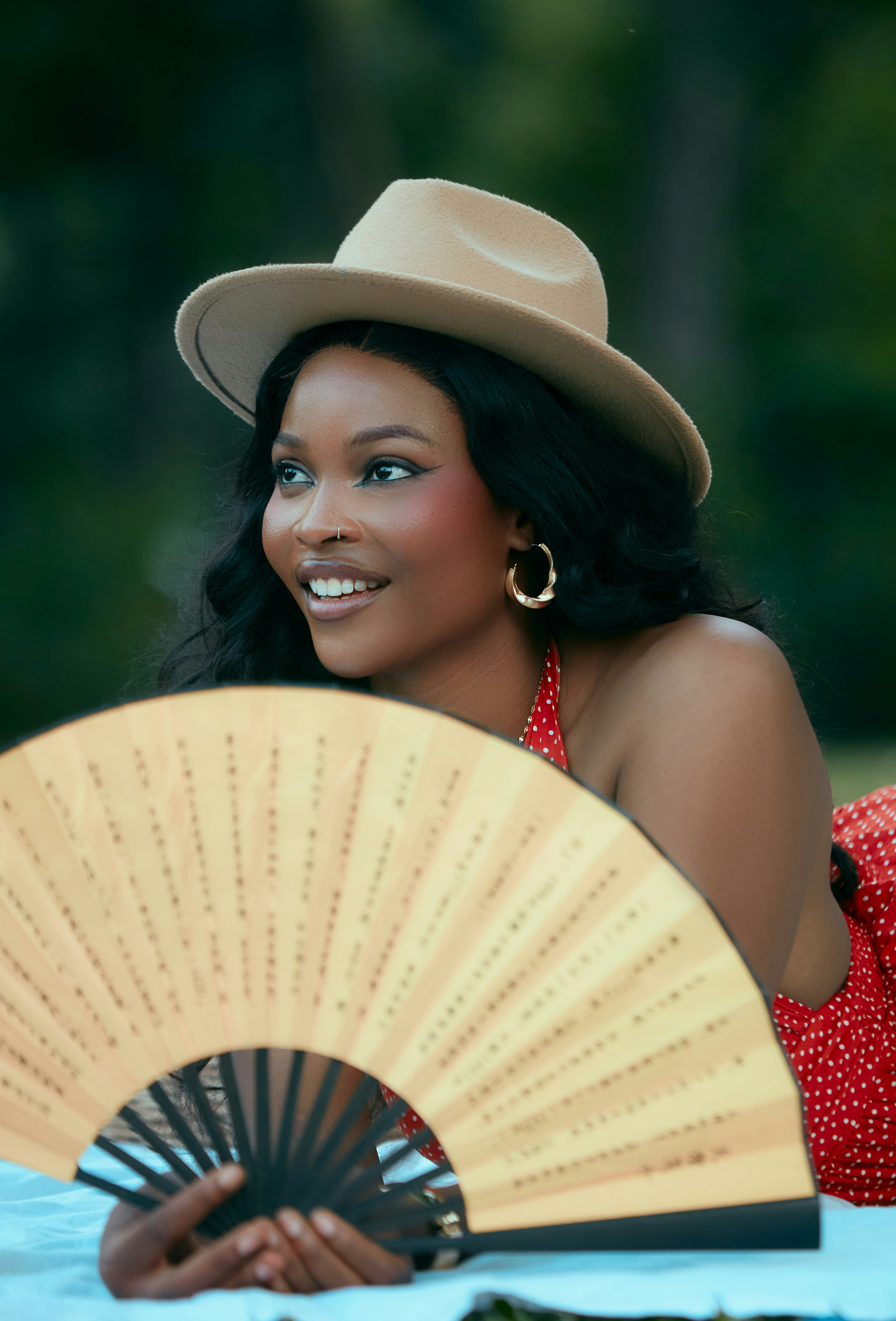 Golden Hour Gaze: Portrait with a Straw Hat and Folding Fan