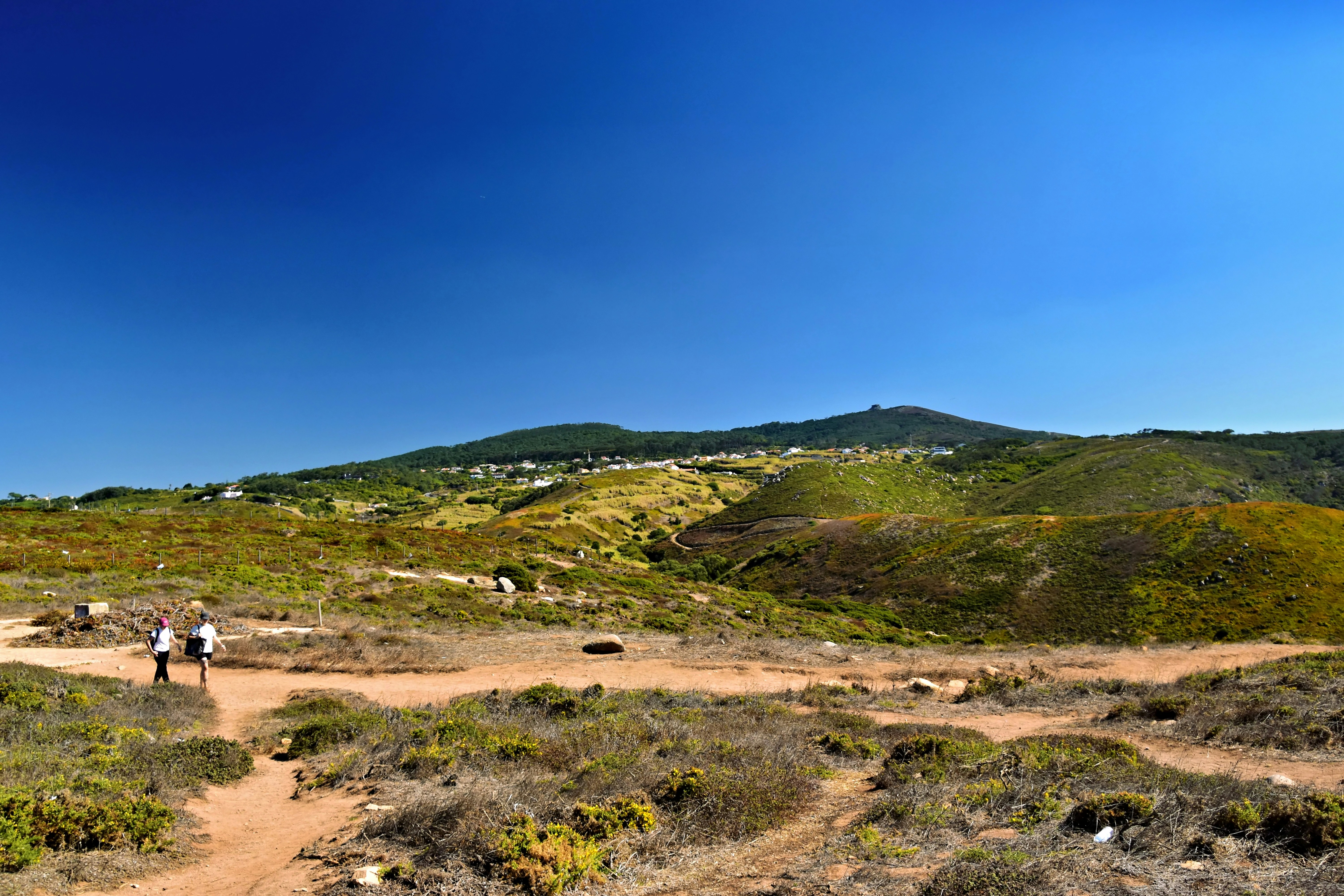 Dusty Trail toward a Distant Ridge Under a Cerulean Sky