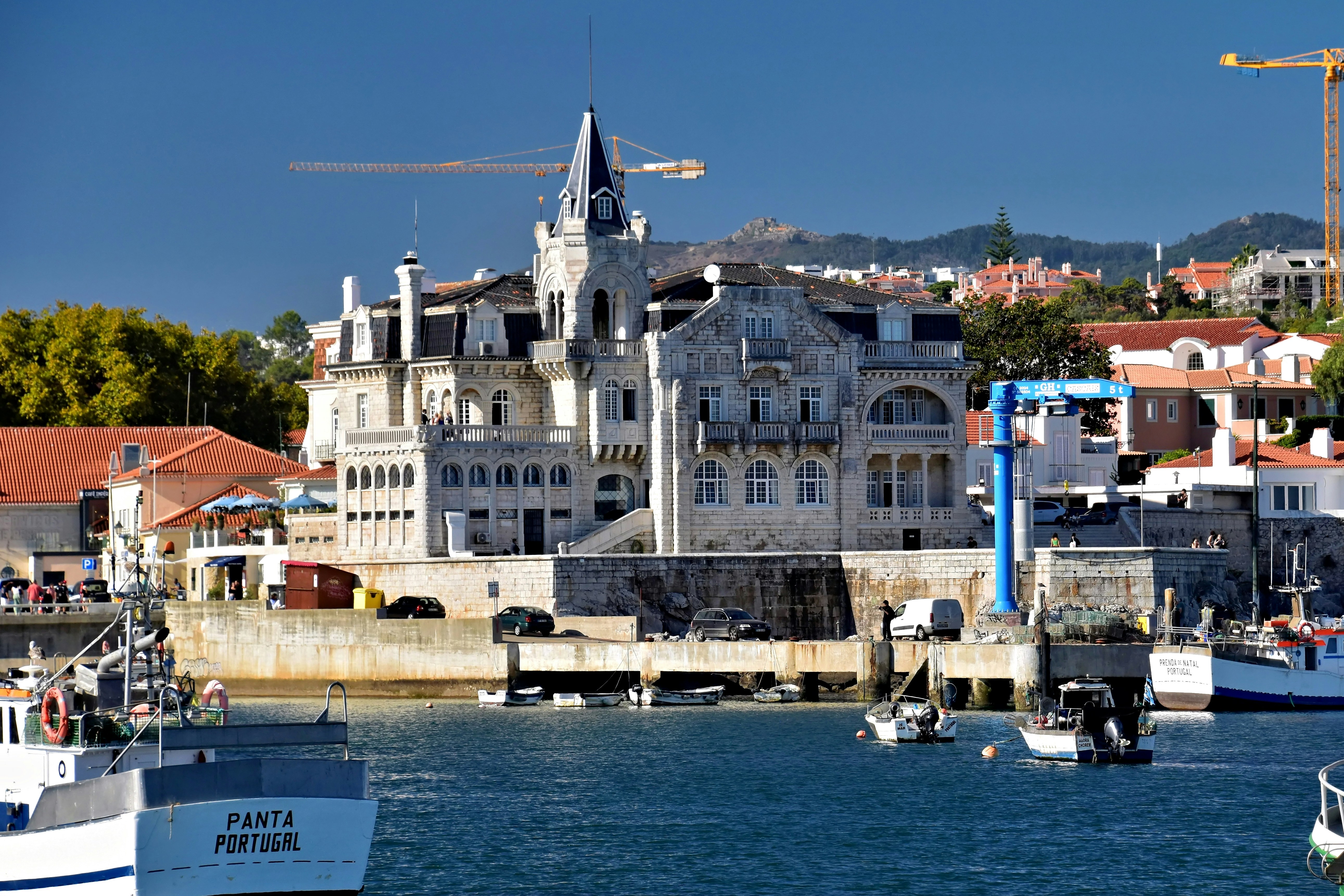 Harborfront White Stone Manor Framed by Cranes