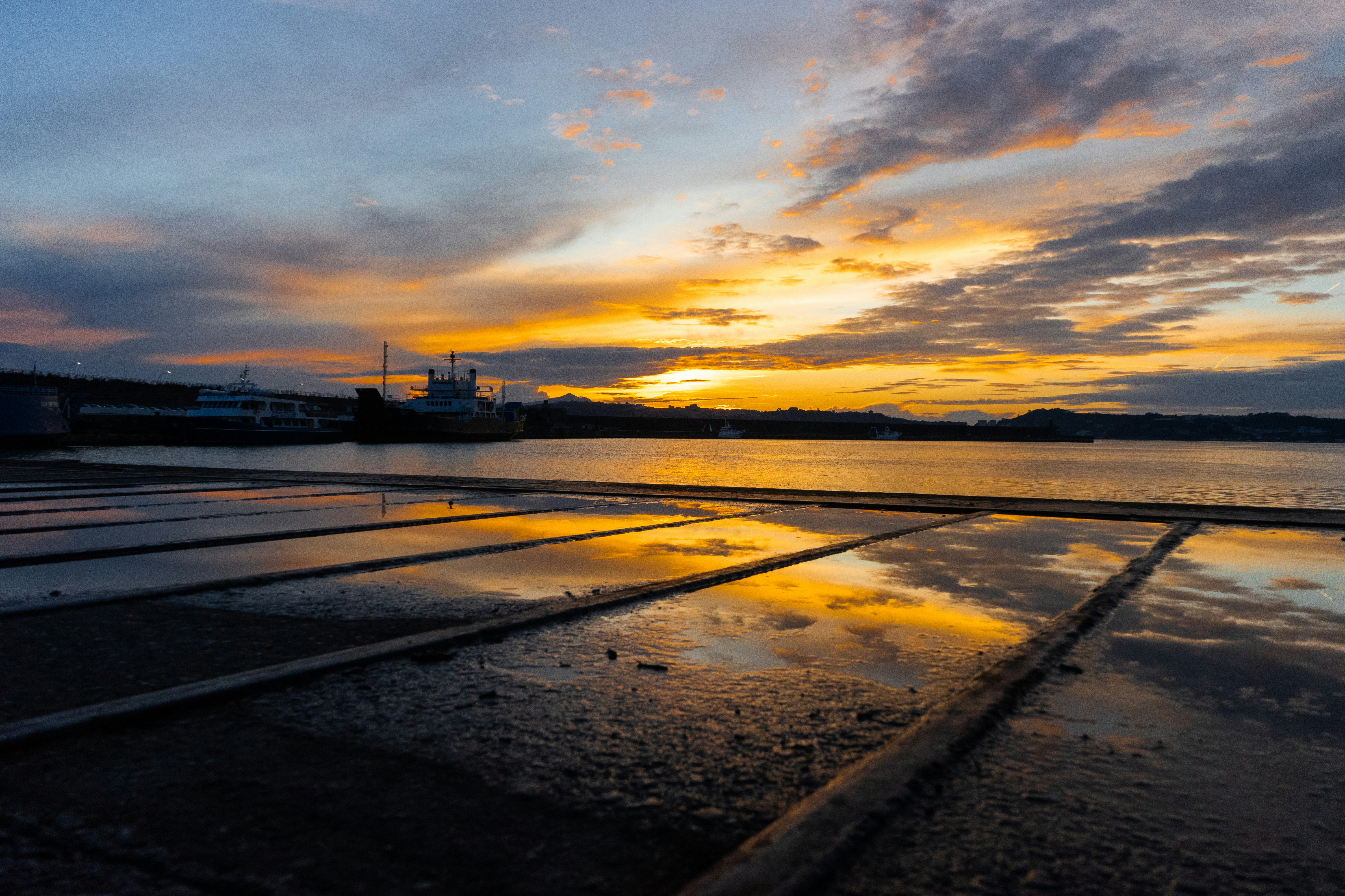 Dusk on the Wet Dock: Parallel Planks Reflect a Mariner Sunset