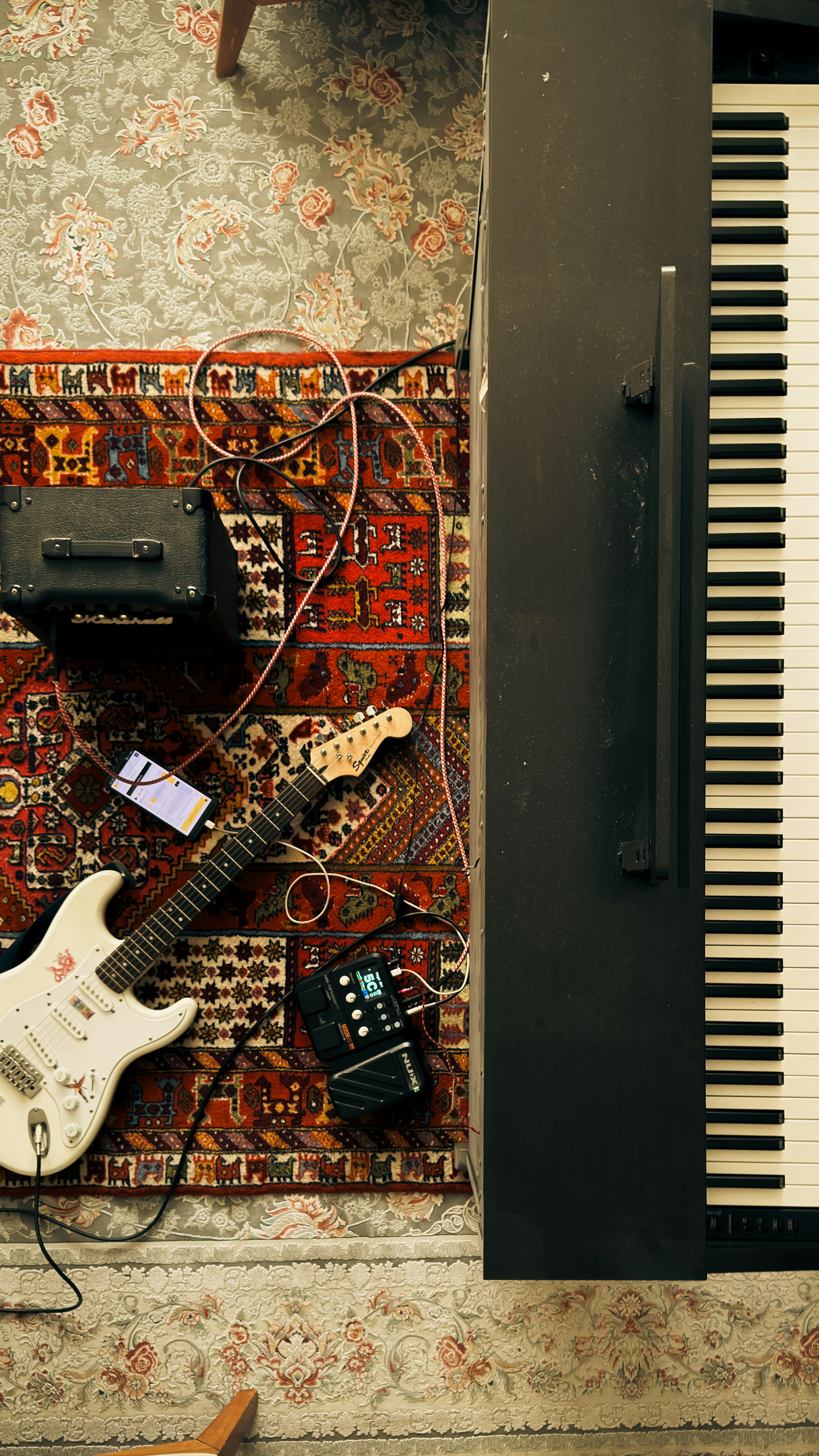 White Strat on a Persian Rug: A Cozy Studio of Strings and Keys