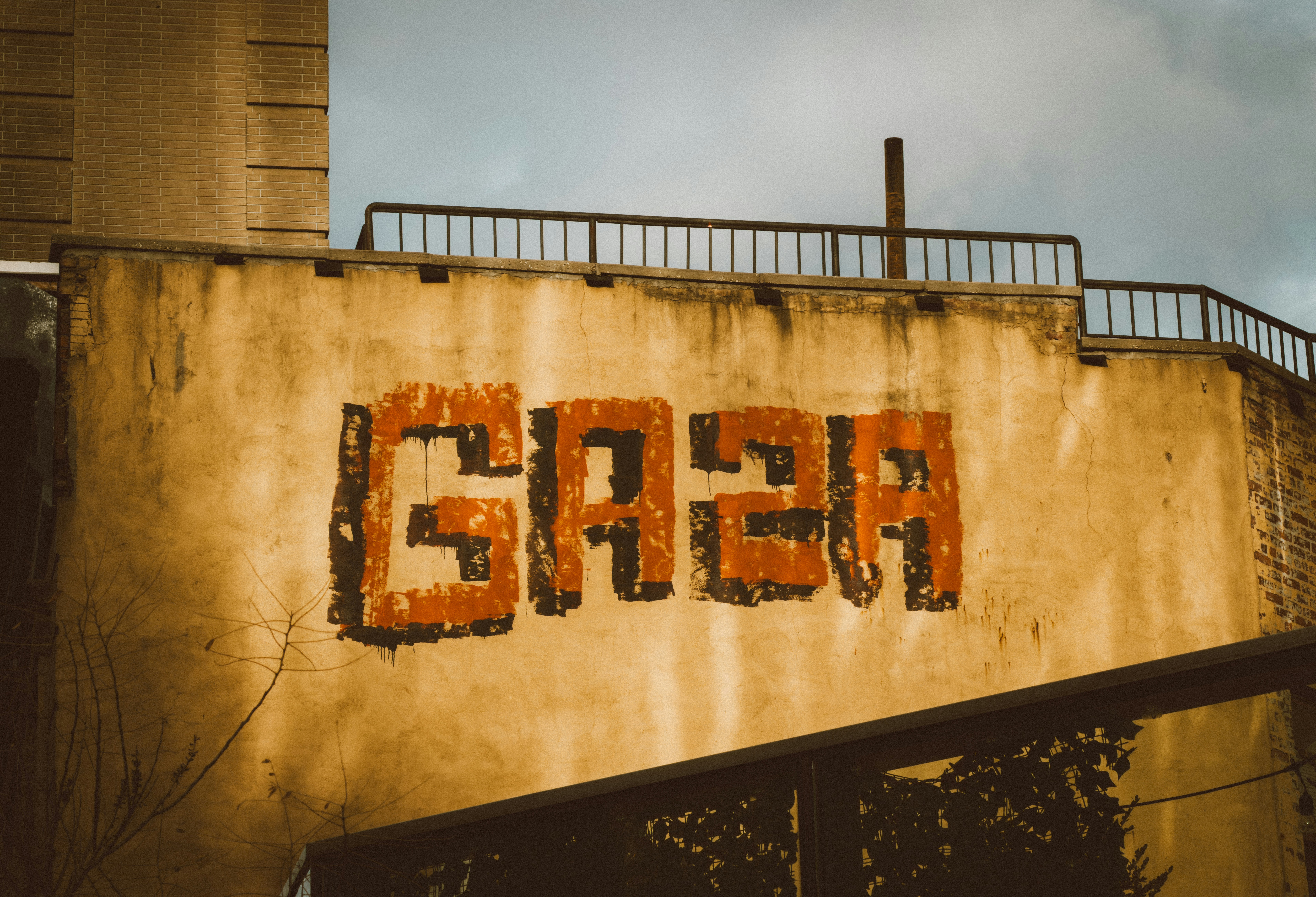 Graffiti spelling out ga2h on a textured wall.