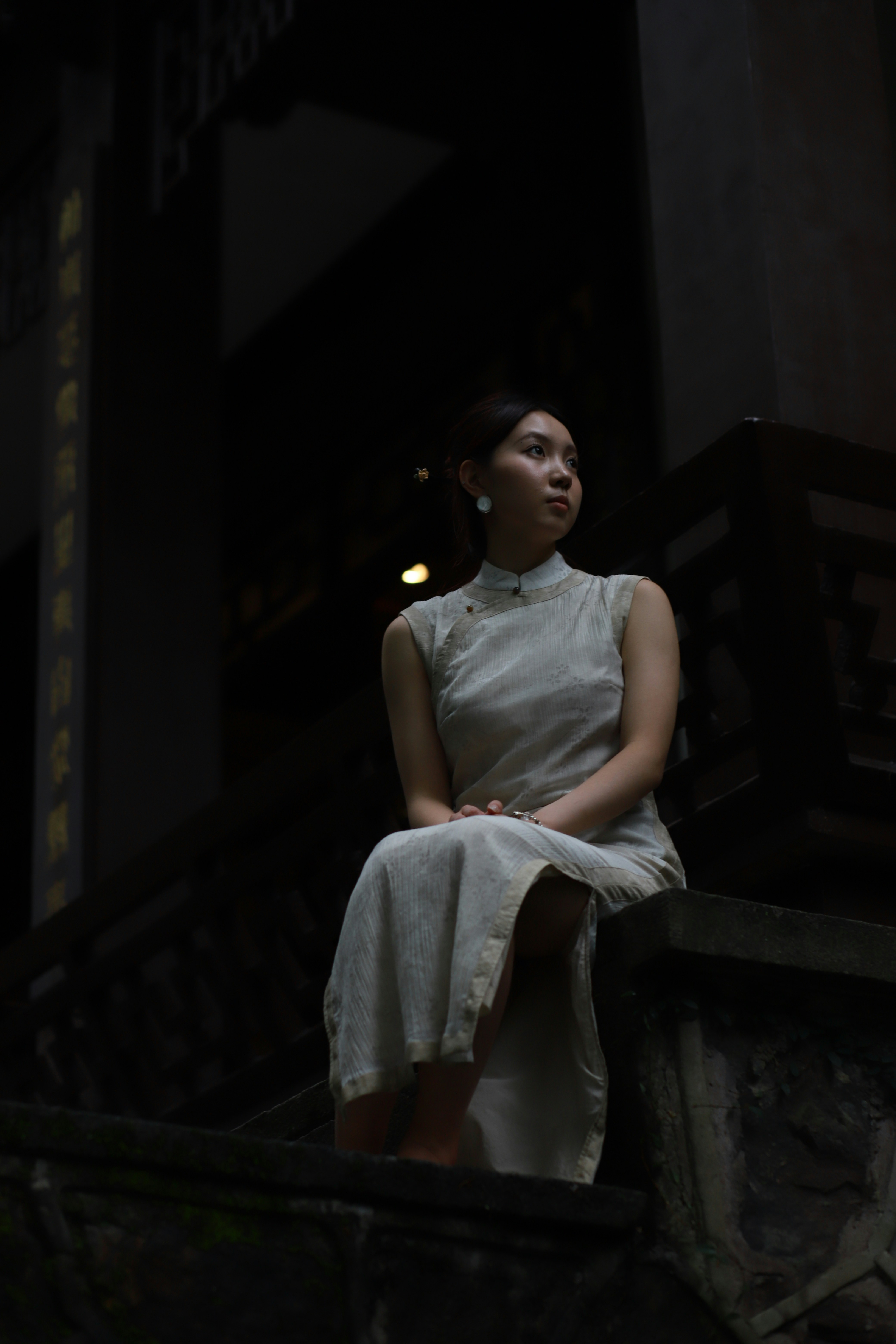 Dim Lantern, Quiet Poise: Portrait on a Stone Balcony