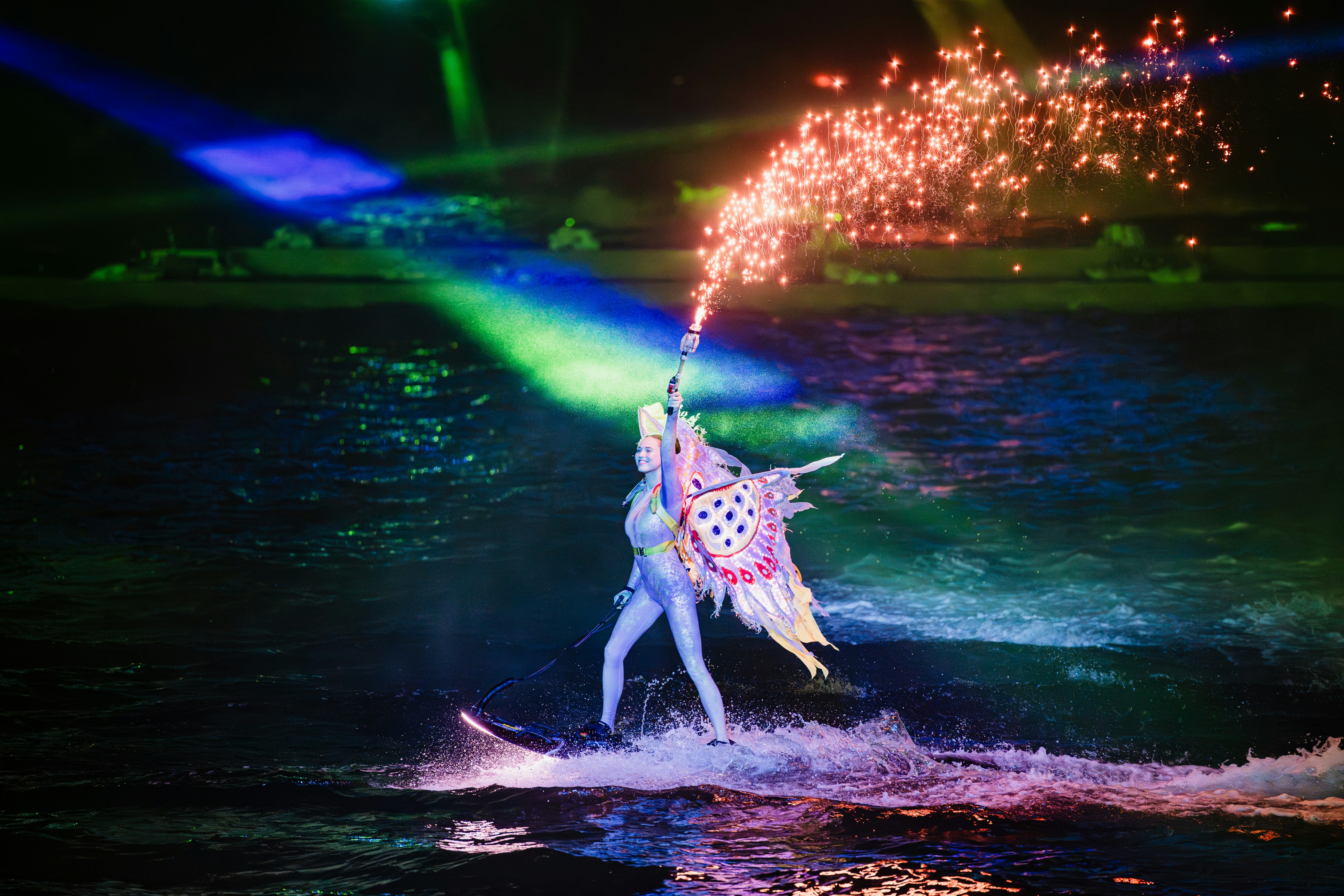 Winged Neon Sparks Across the Night Sea