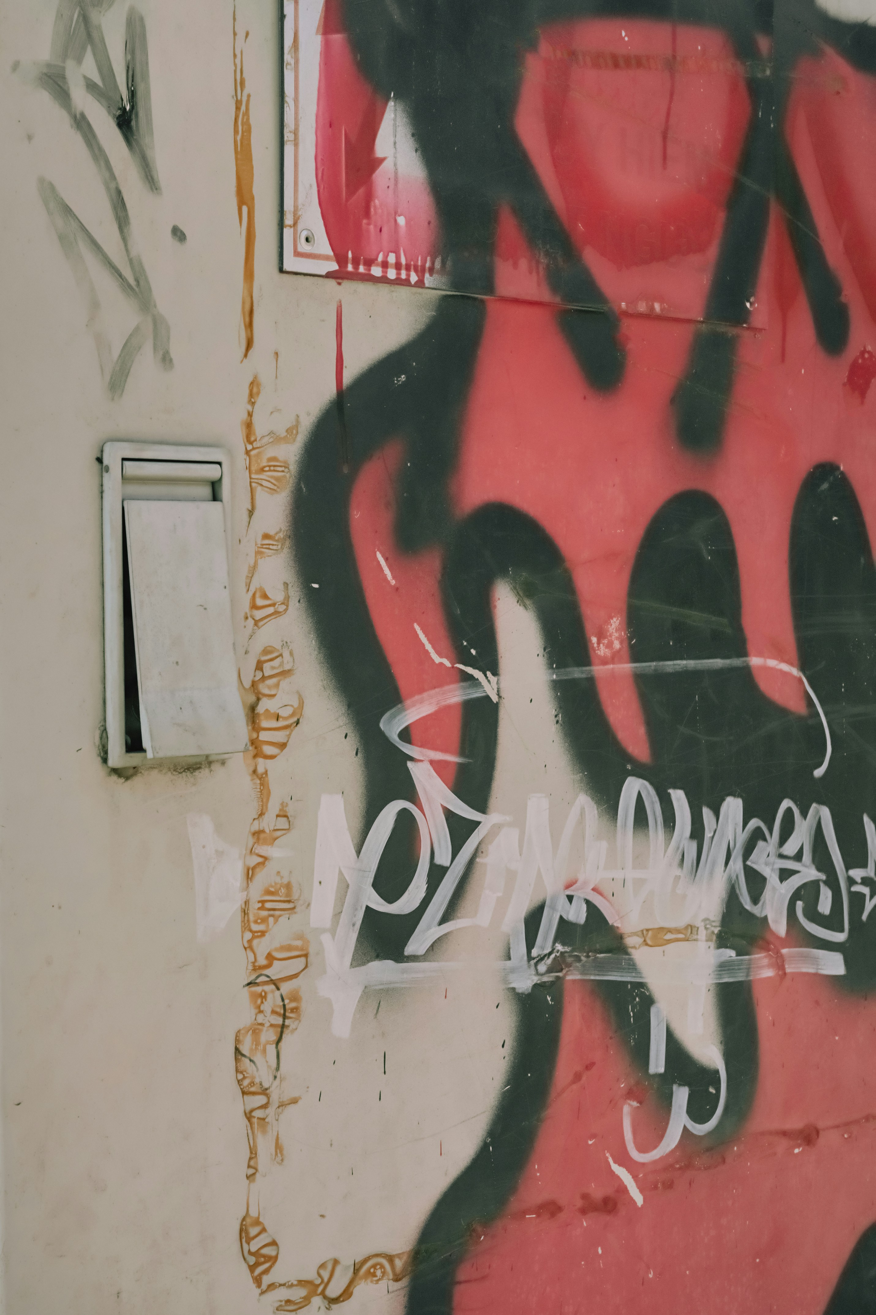 Crimson Graffiti Glyphs Draped Across a Weathered Wall