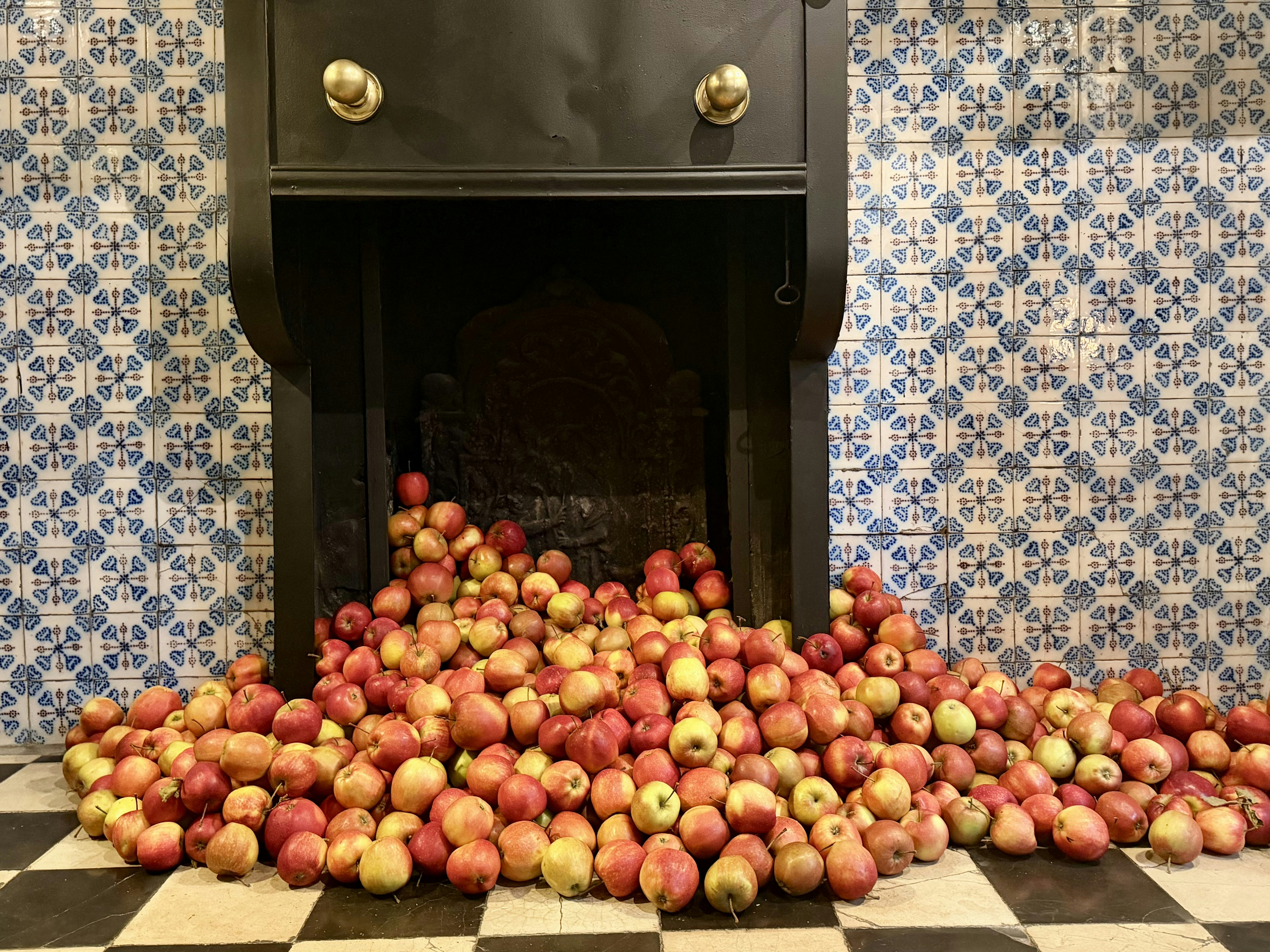 Hearthside Orchard: A Cascade of Apples Framing a Vintage Stove