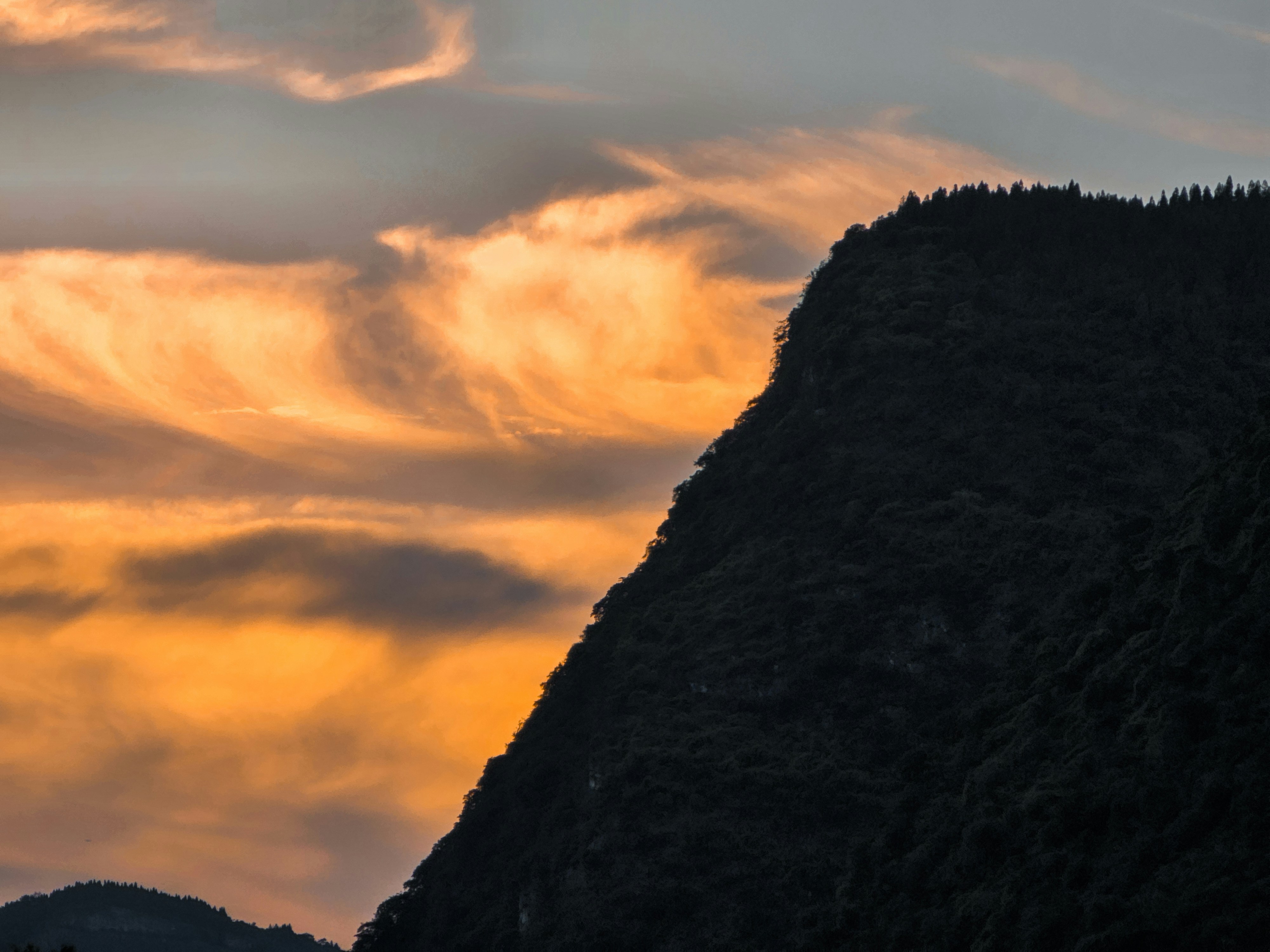 Ridge at Dusk: Silhouette Against a Molten Sky