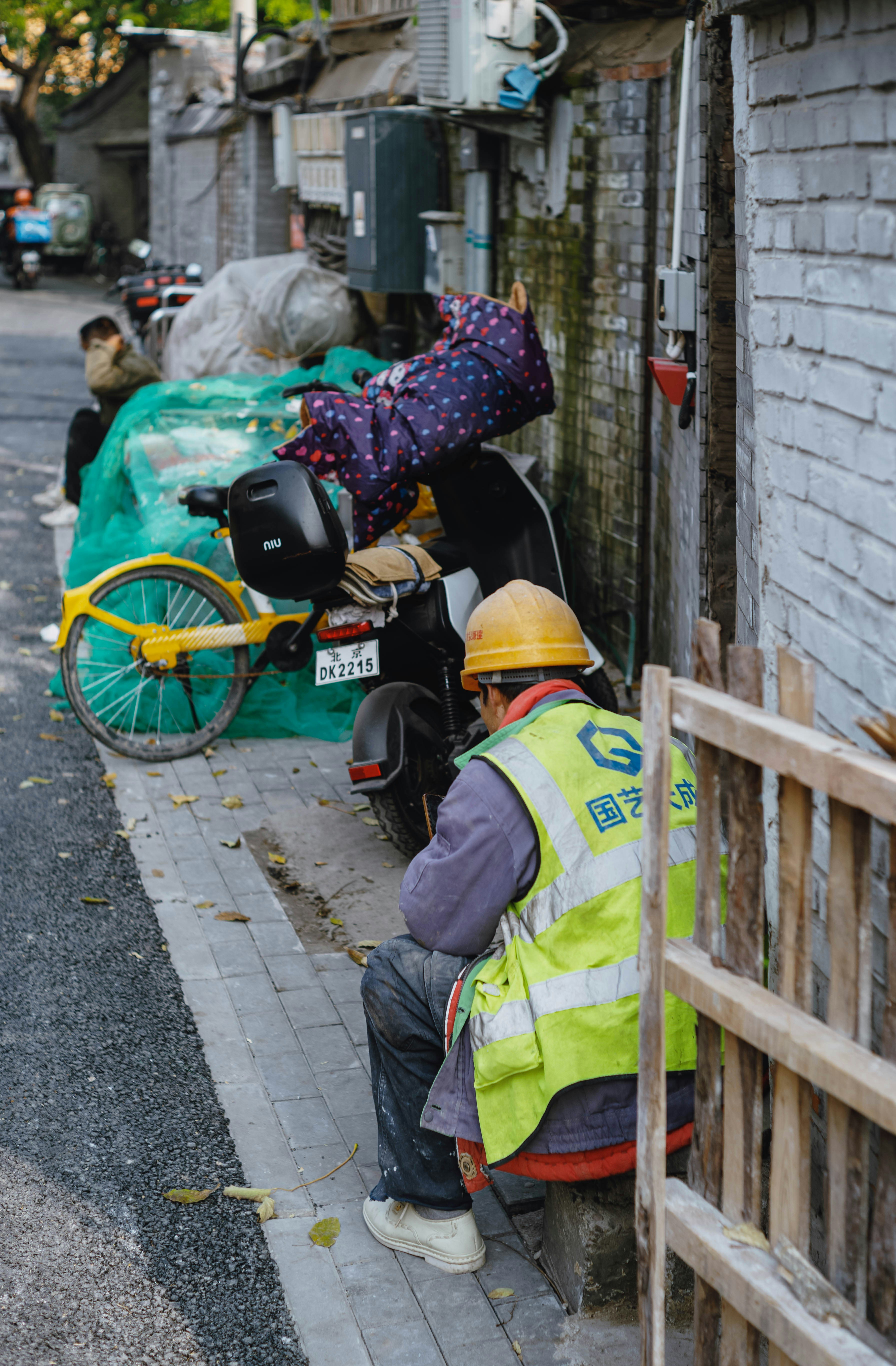 Neon Vest at the Alley’s Edge: A Street-Scene Pause