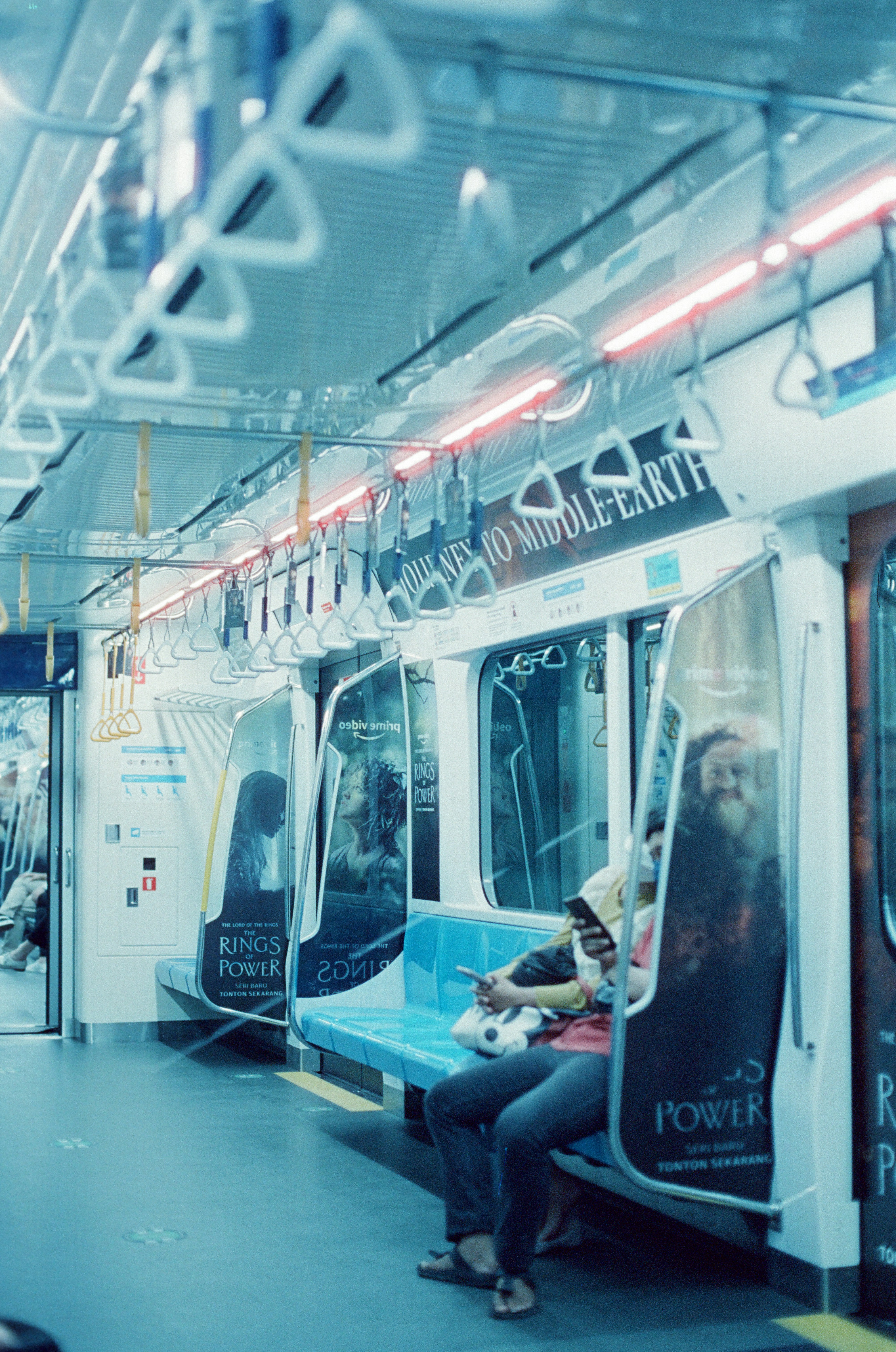 People sitting inside a train carriage with advertisements photo – Free ...
