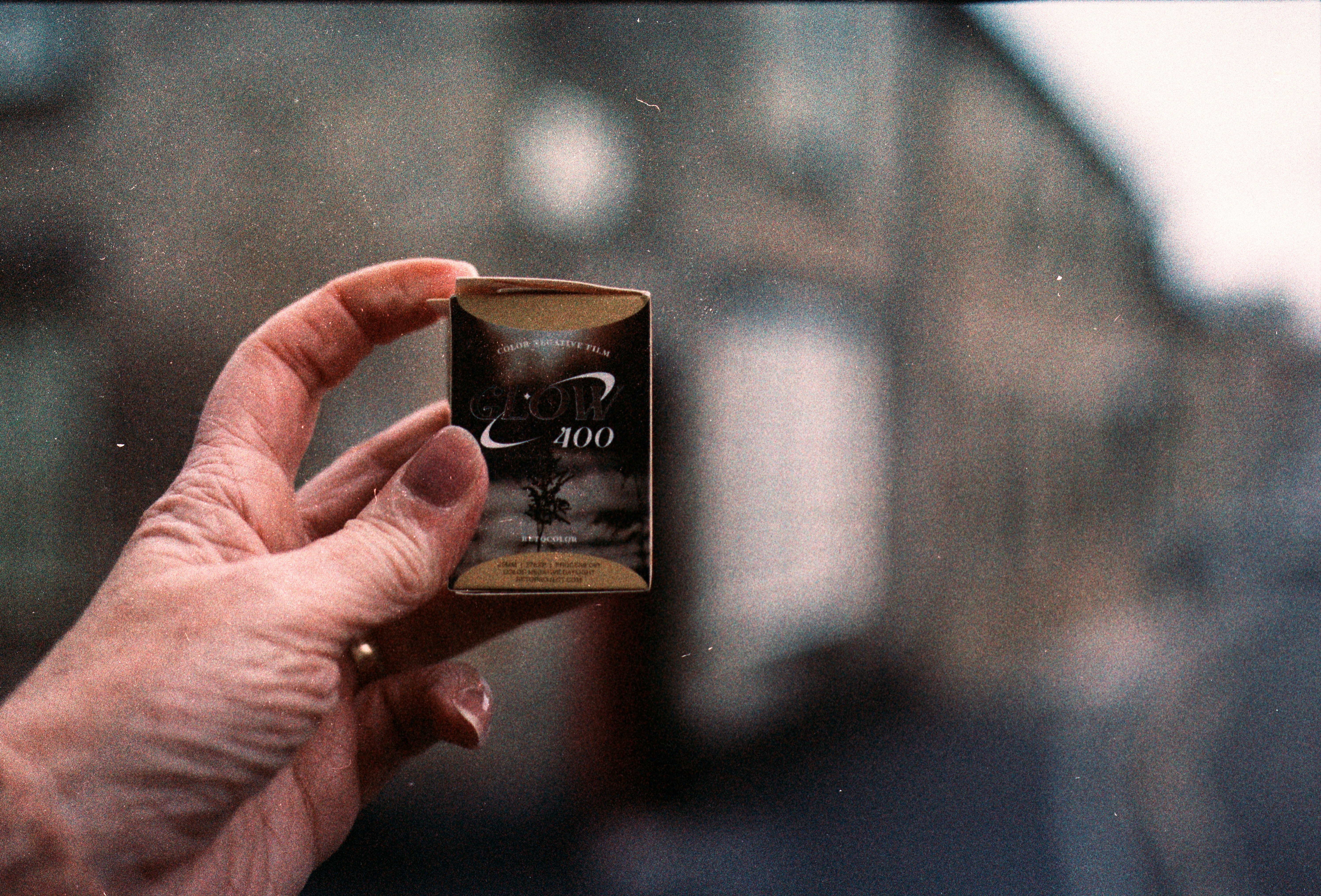 Close-Up of a Cigarette Pack Framed by a Blurred Urban Street
