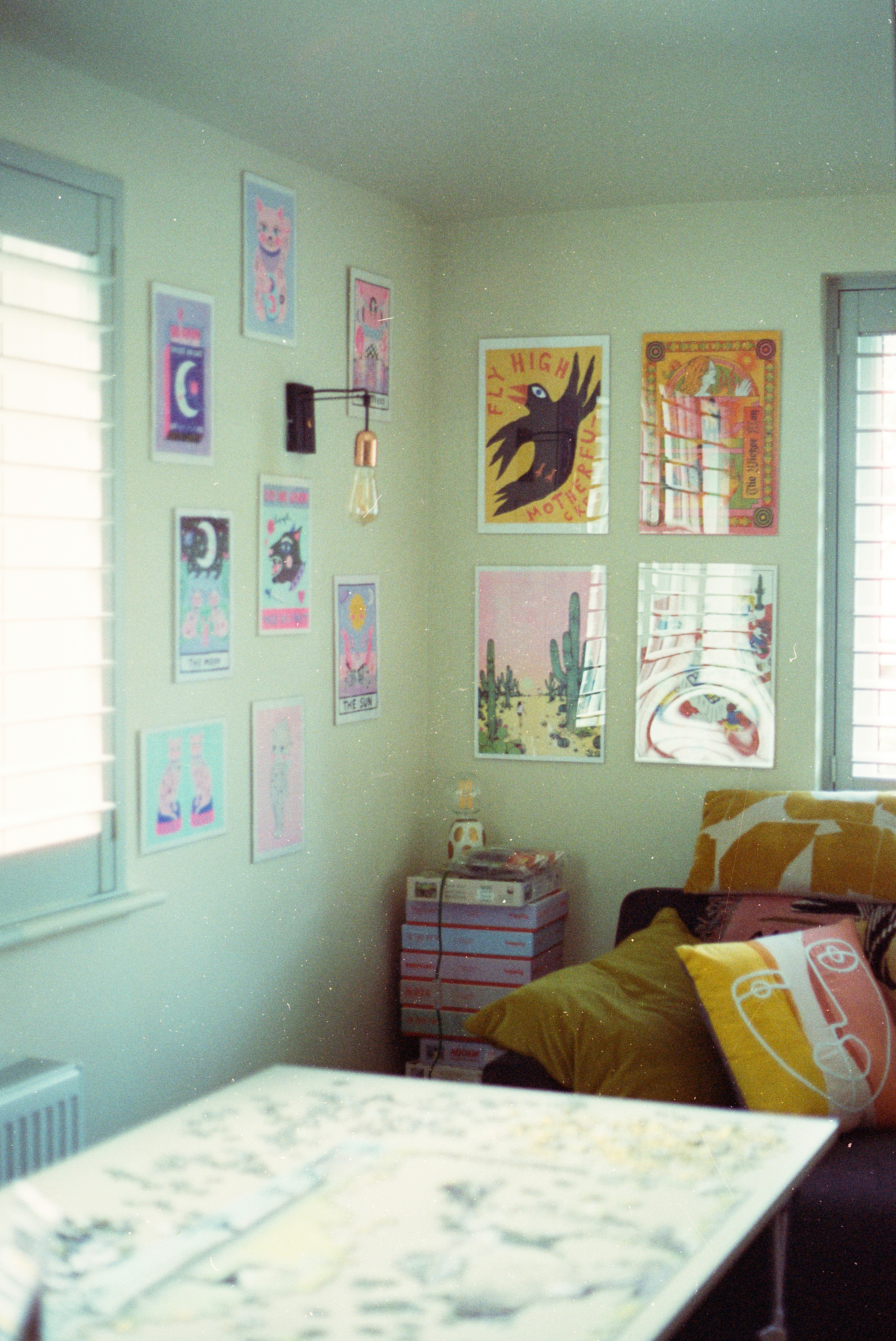 Eclectic wall art and pillows in a cozy room.