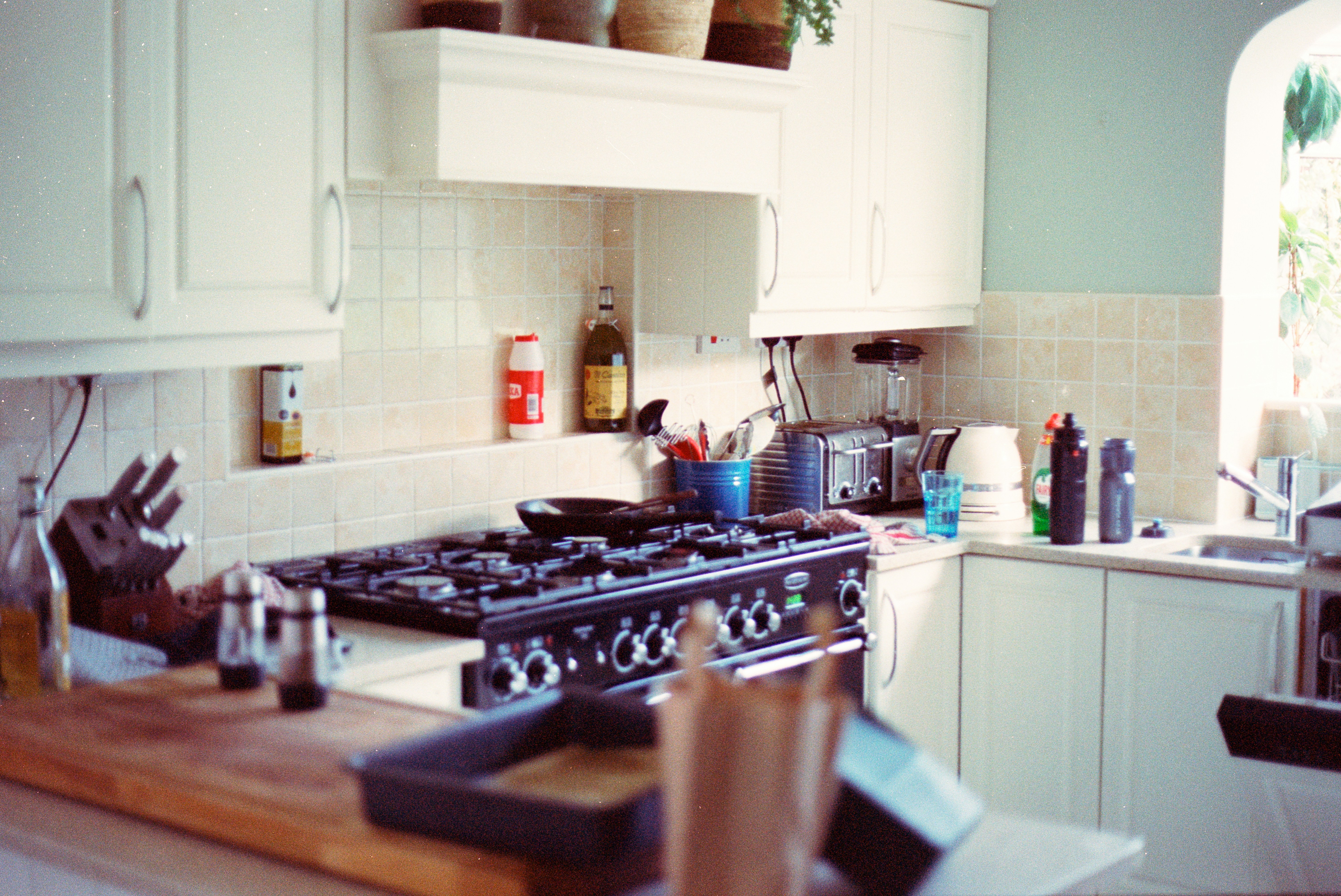 A traditional kitchen with a black gas stove.