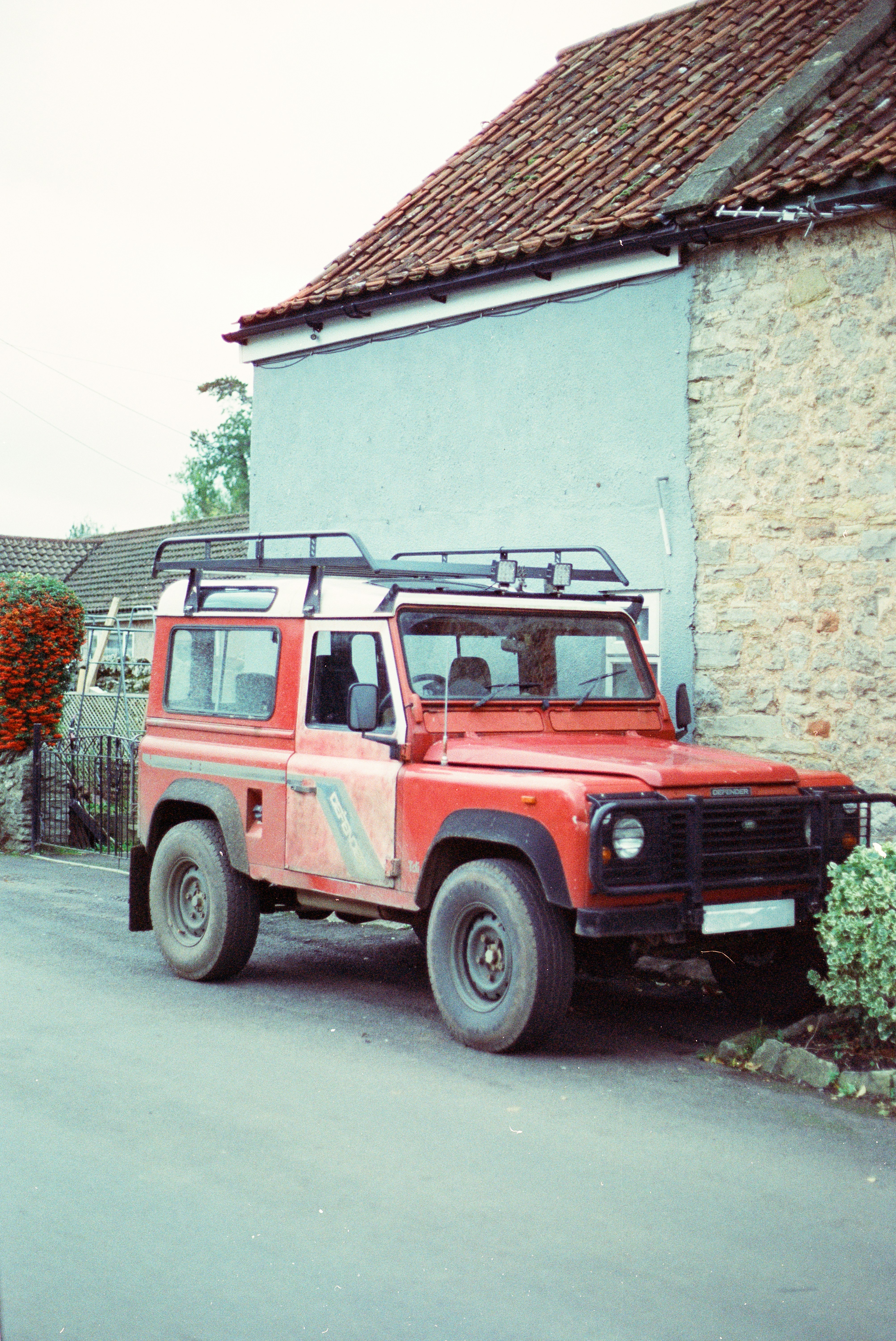 Red off-road vehicle parked near a building