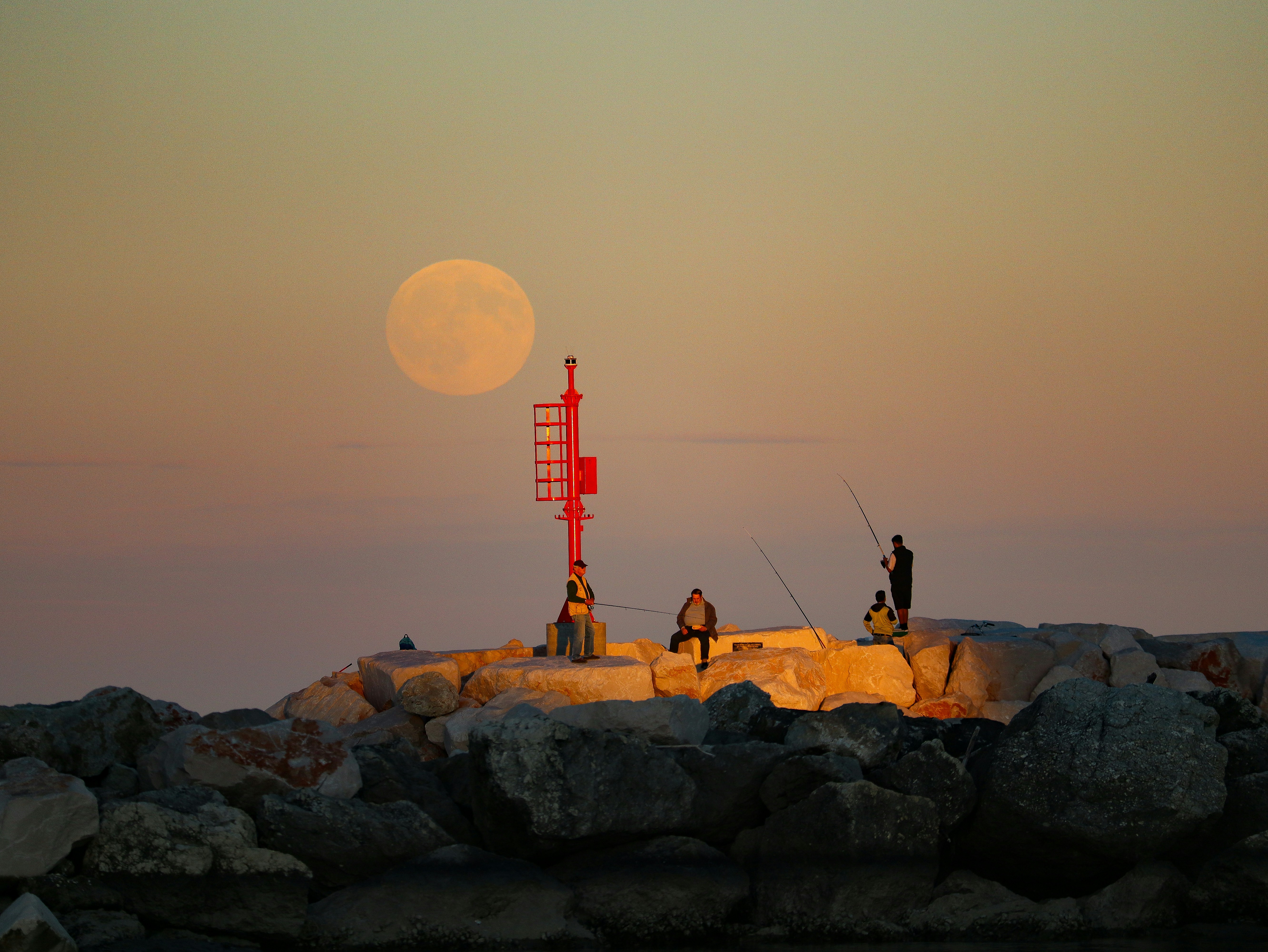 Moonrise Over the Breakwater: Crimson Tower and Silent Anglers