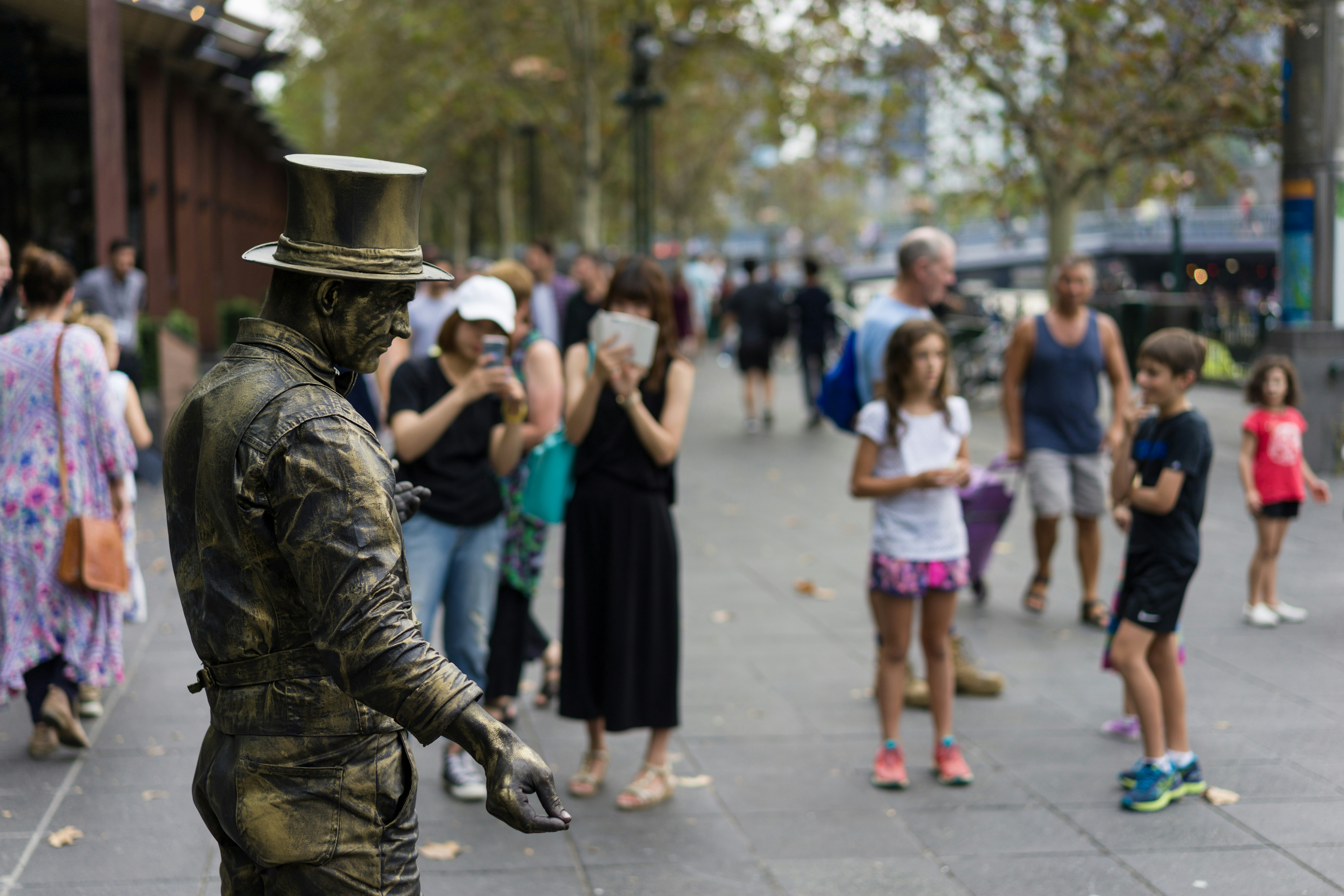 Top-Hatted Bronze Figure Guards the Street