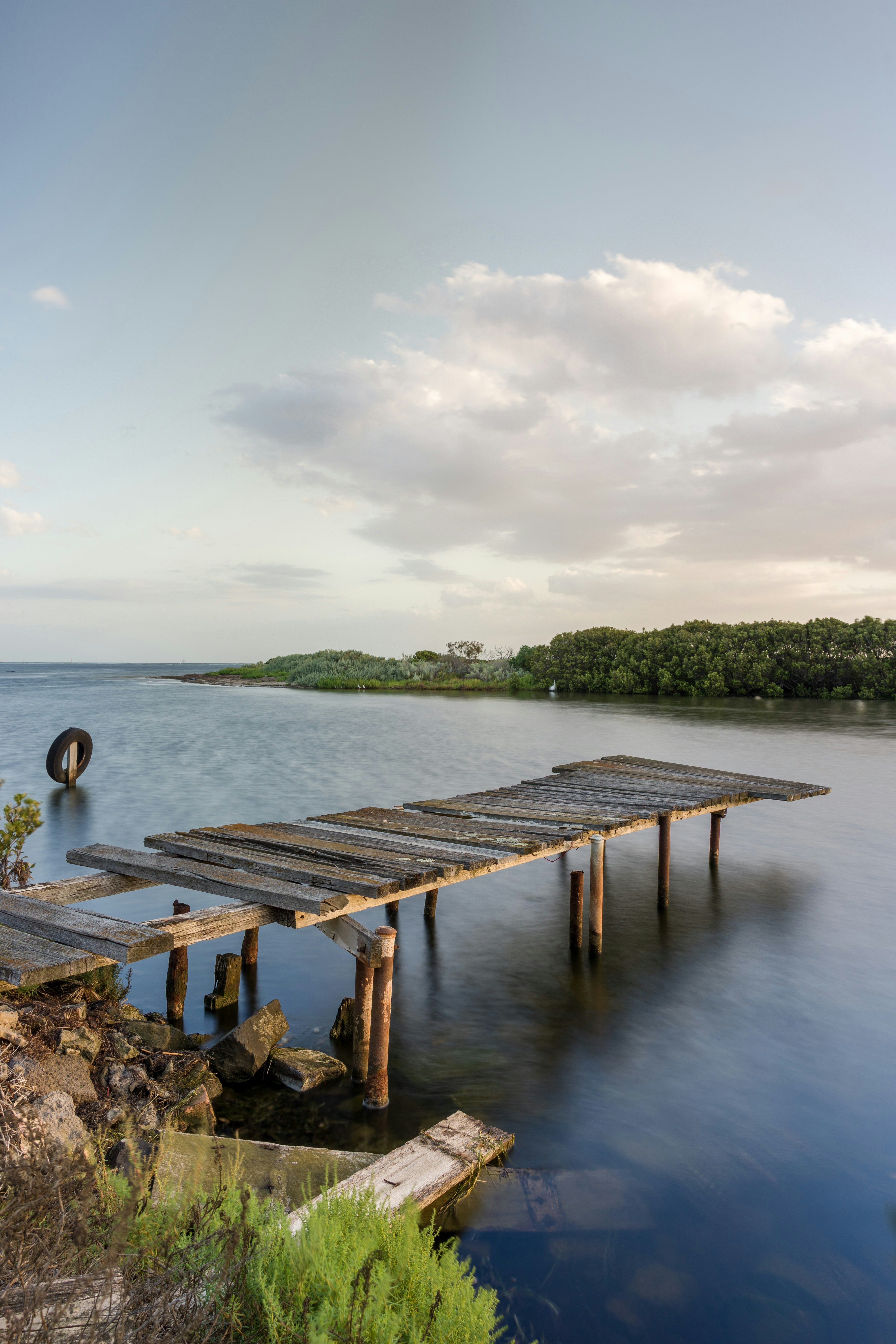 Planks to the Quiet Horizon: A Weathered Pier Reaches the Sea