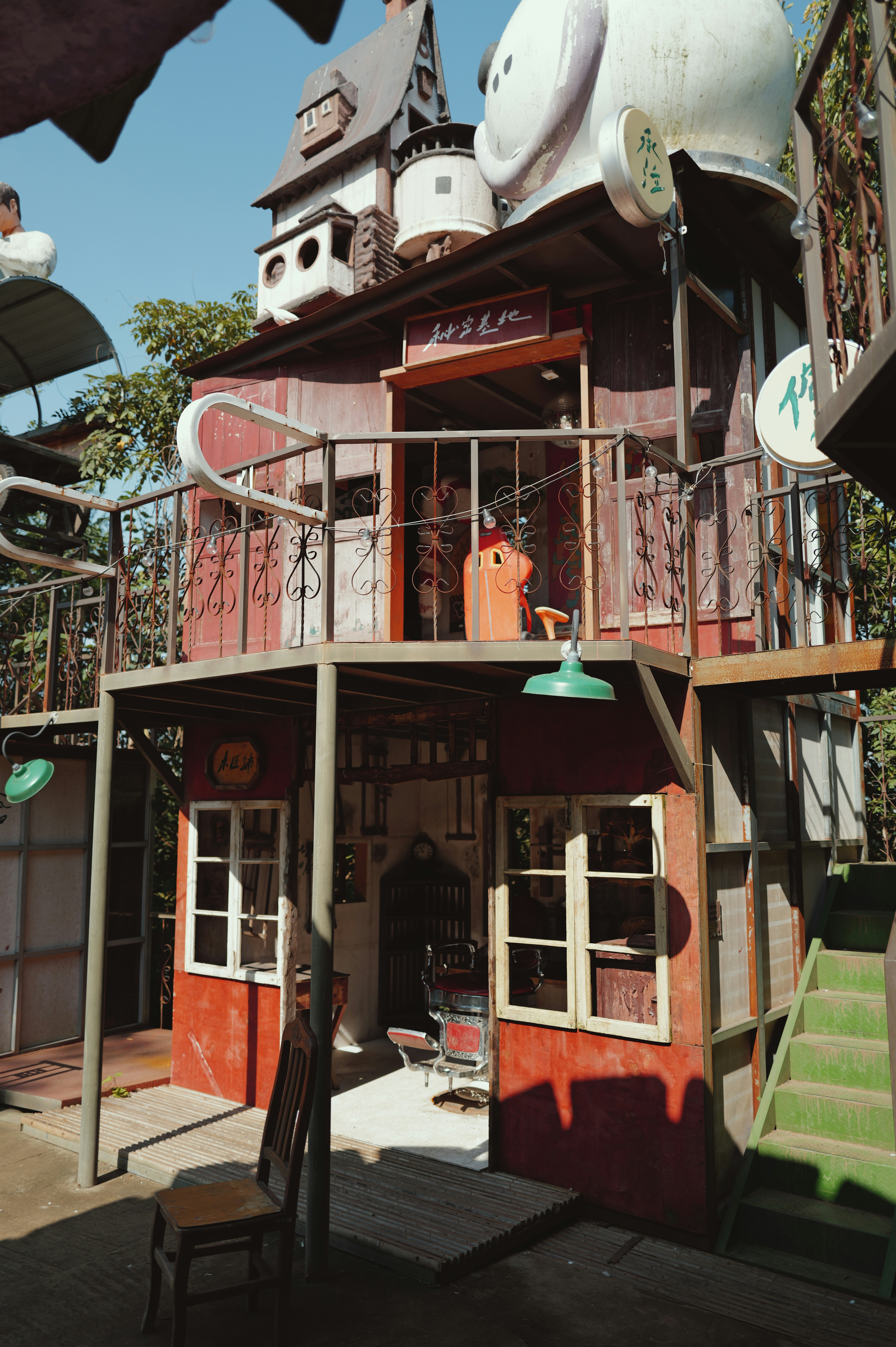 Pig on the Balcony: A Whimsical Red Facade with Iron Railings