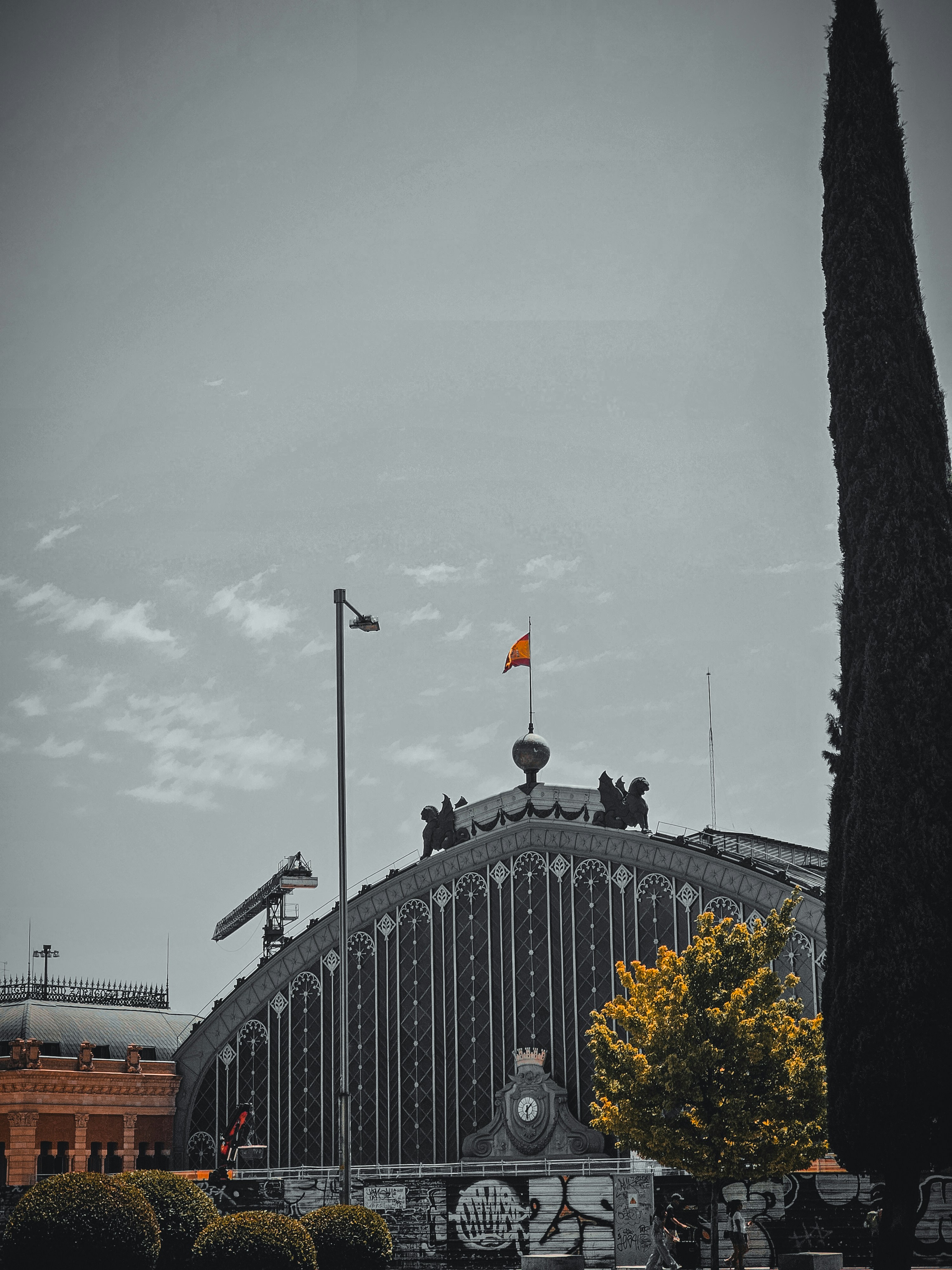 Arches, Flag, and a Glowing Tree: A Station's Quiet Geometry