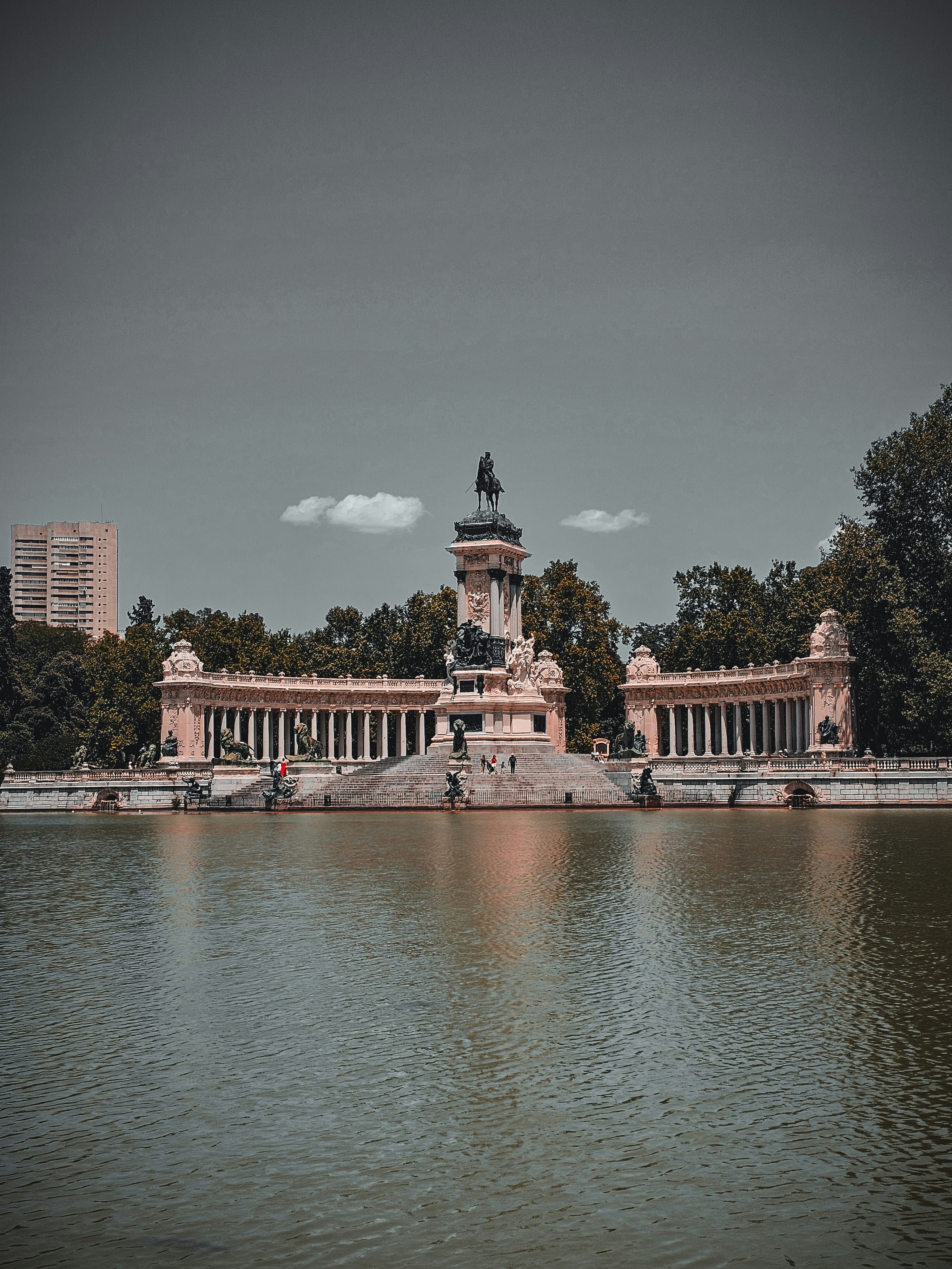 Equestrian Monument Framed by Symmetrical Colonnades Across a Quiet Lake