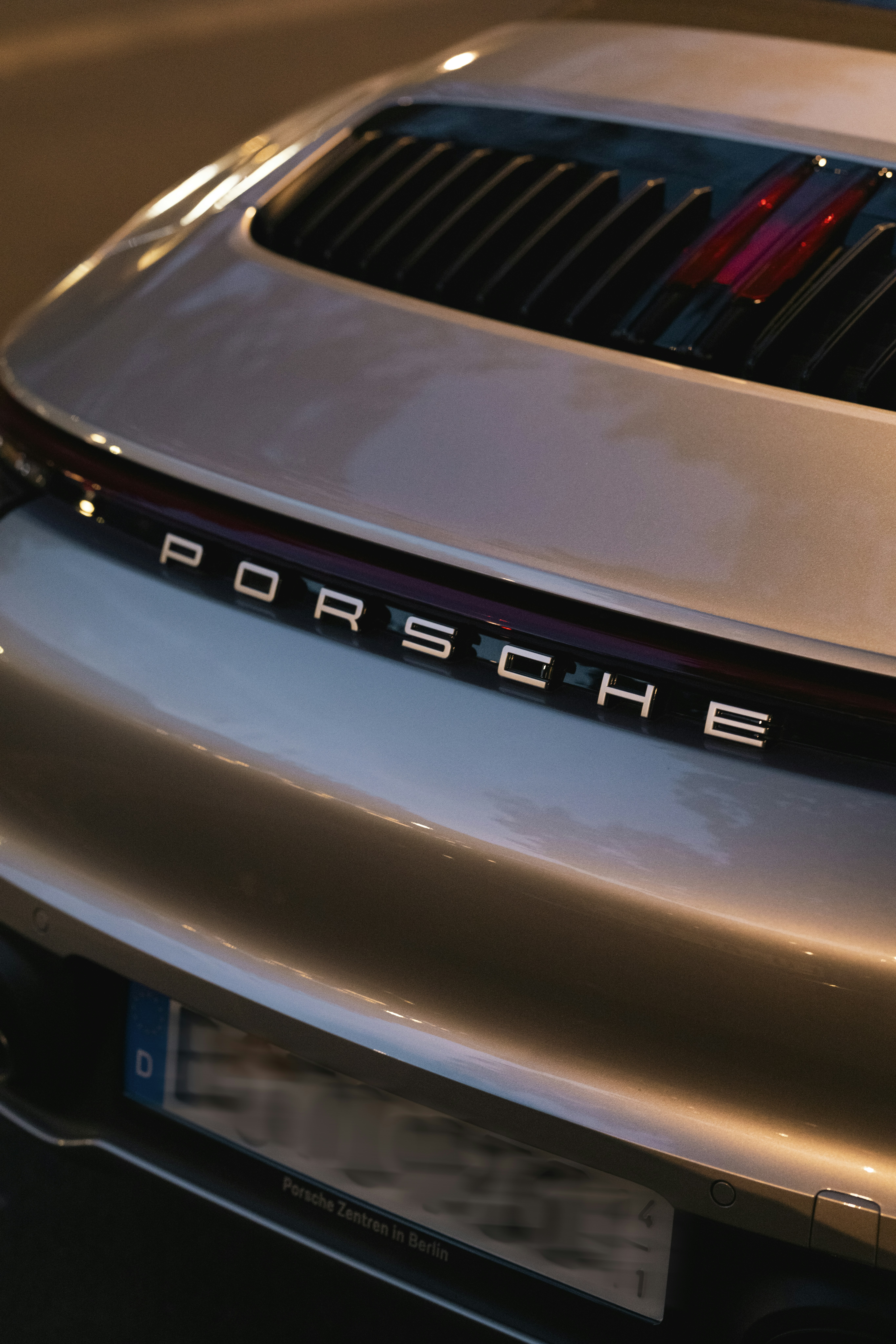 Rear Emblem at Dusk: The Silvery Pulse of Porsche