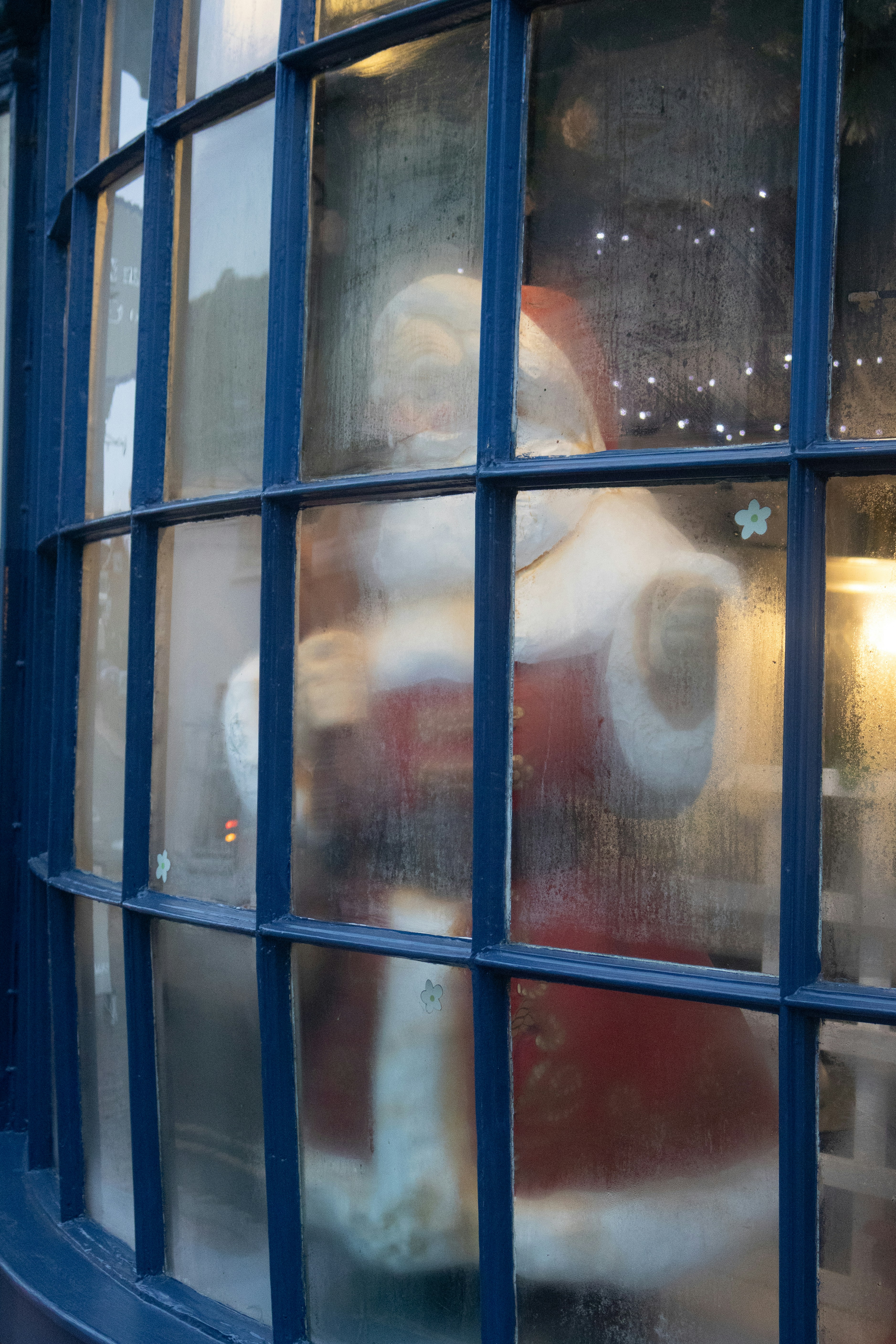 Santa Peeks Through Frosted Cobalt Window Grids