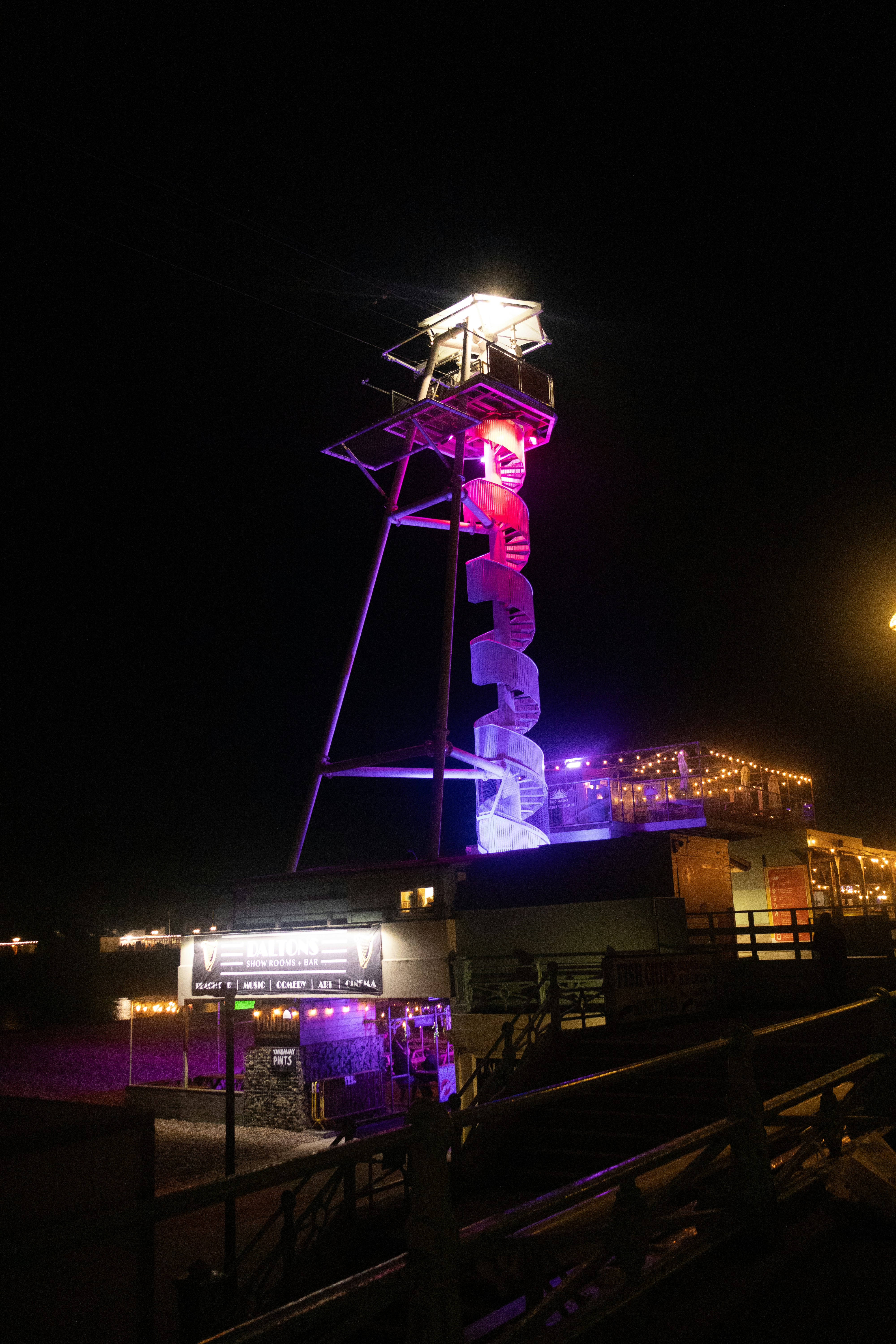 Neon Spiral Tower Lights Up the Night Pier