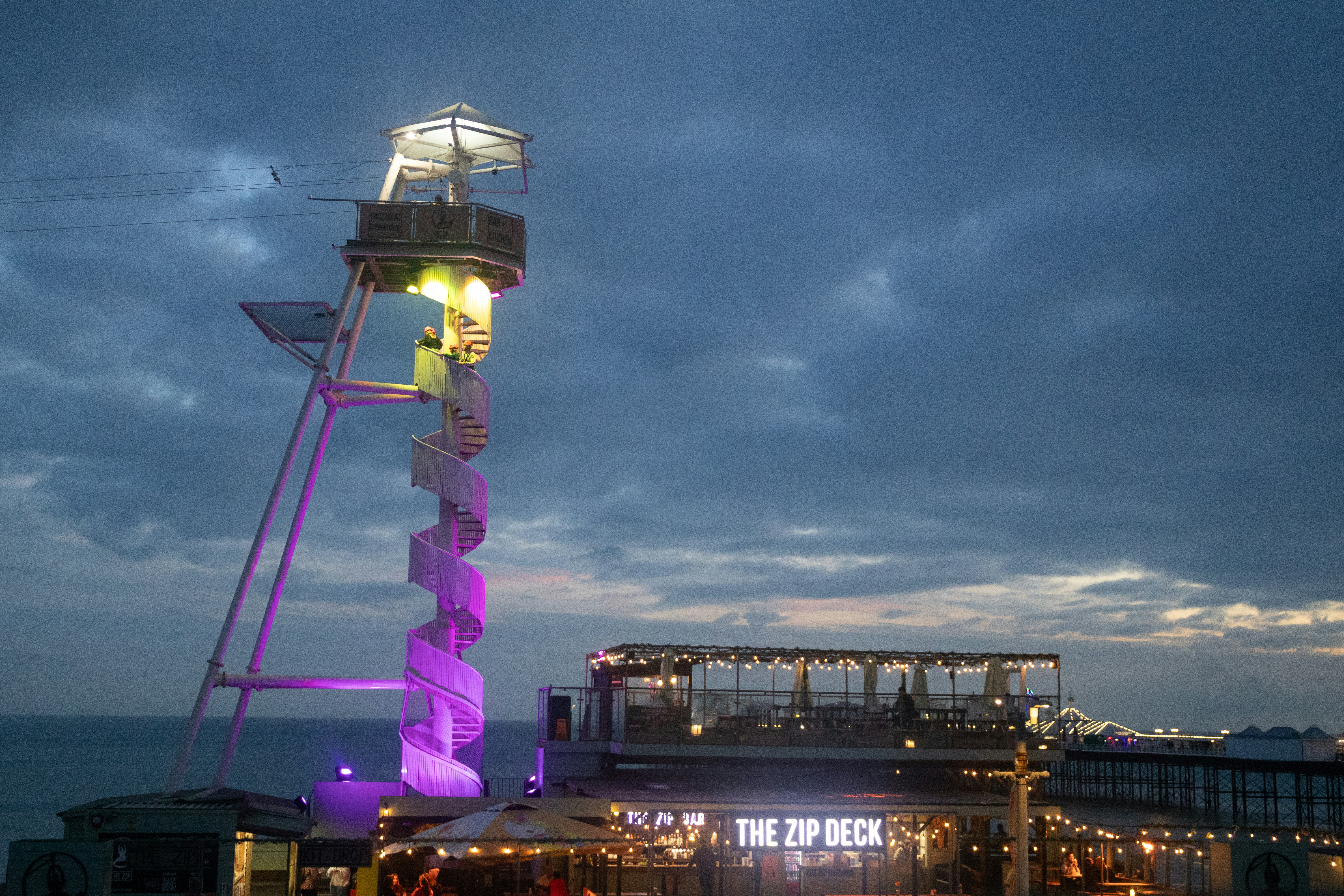 Neon Spiral Tower Illuminates the Dusk Pier