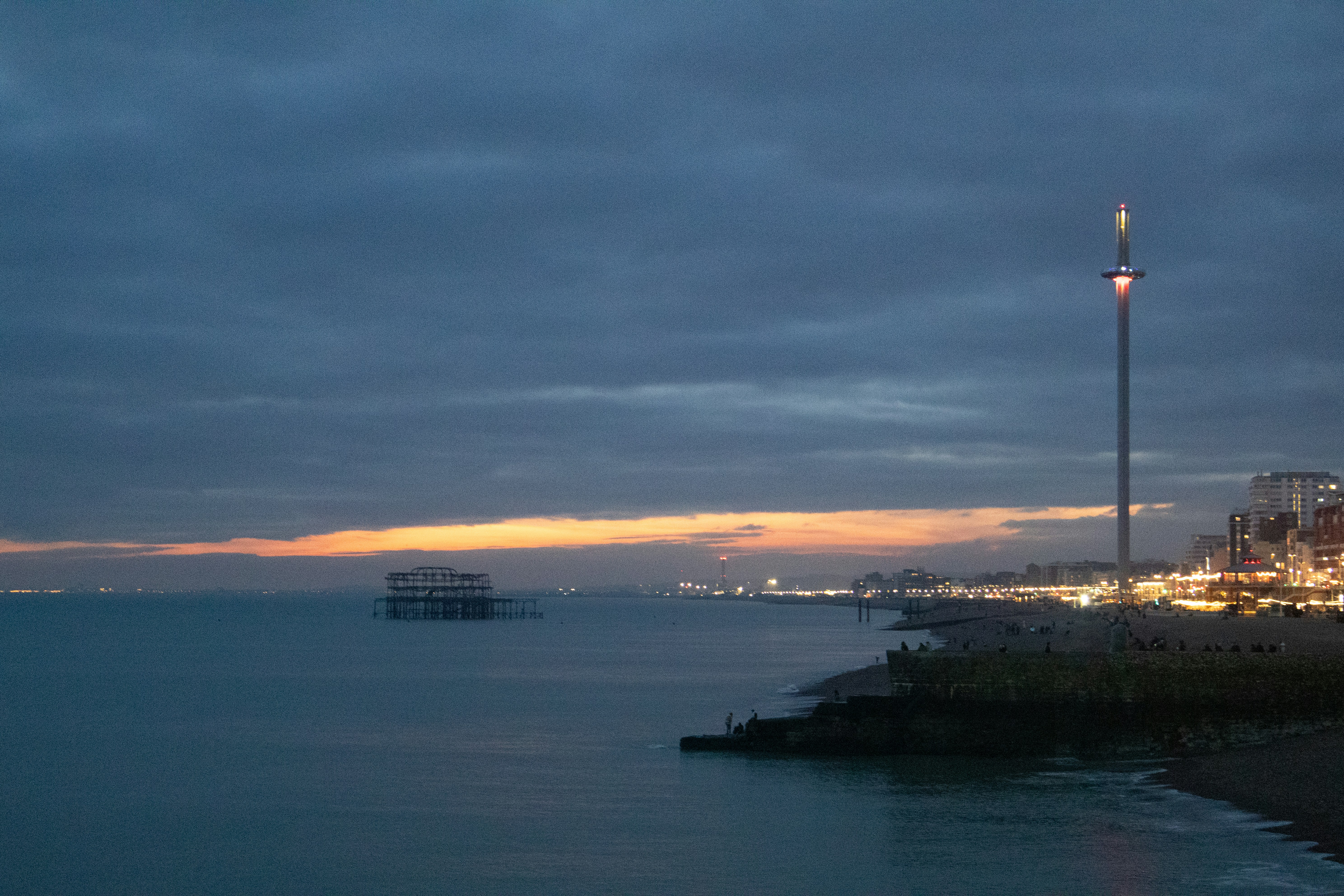 Dusk Beacon Over a Quiet Coastal Cityscape