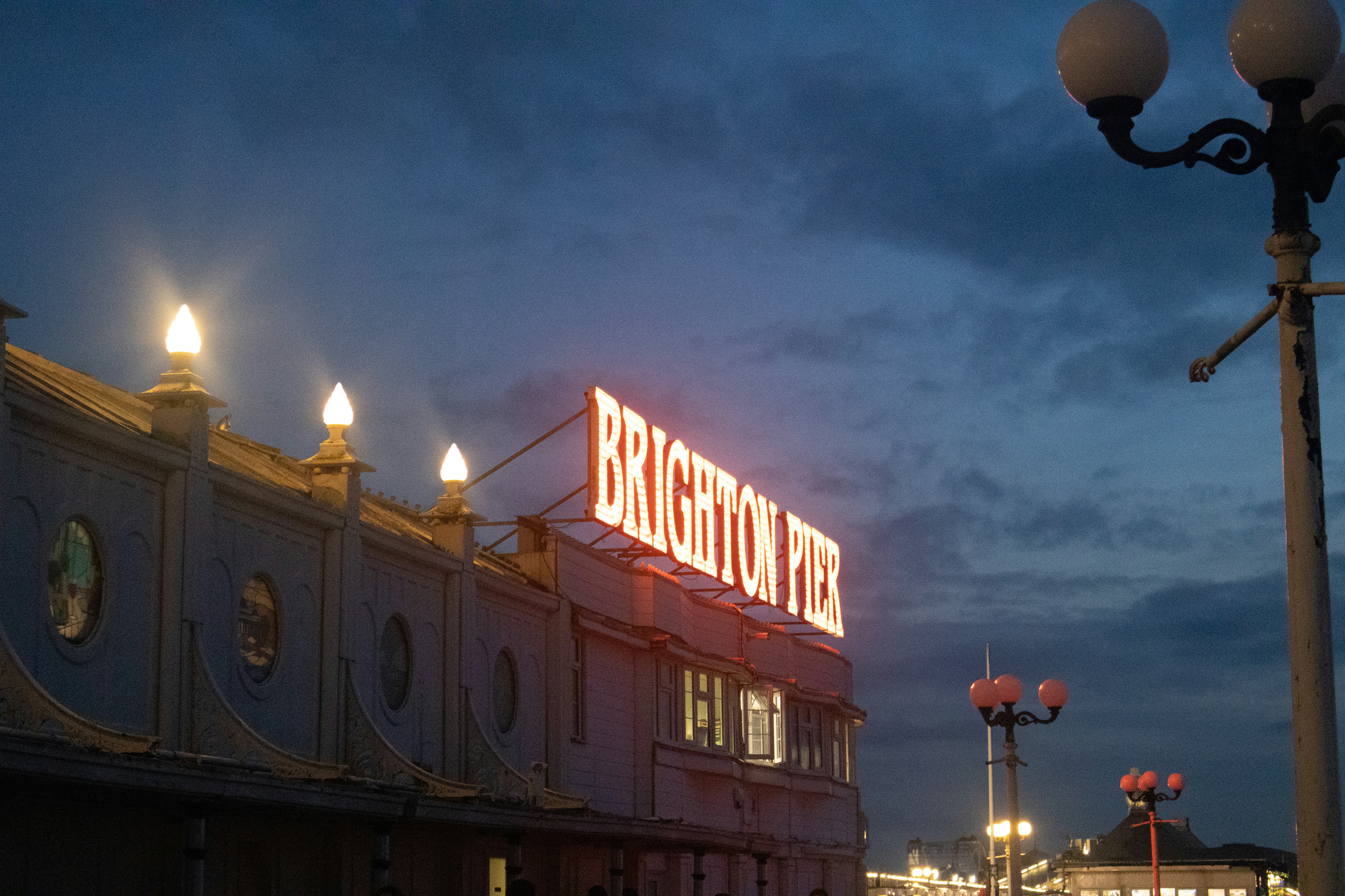 Luminescent Promenade: The Brighton Pier Neon Sign at Blue Hour