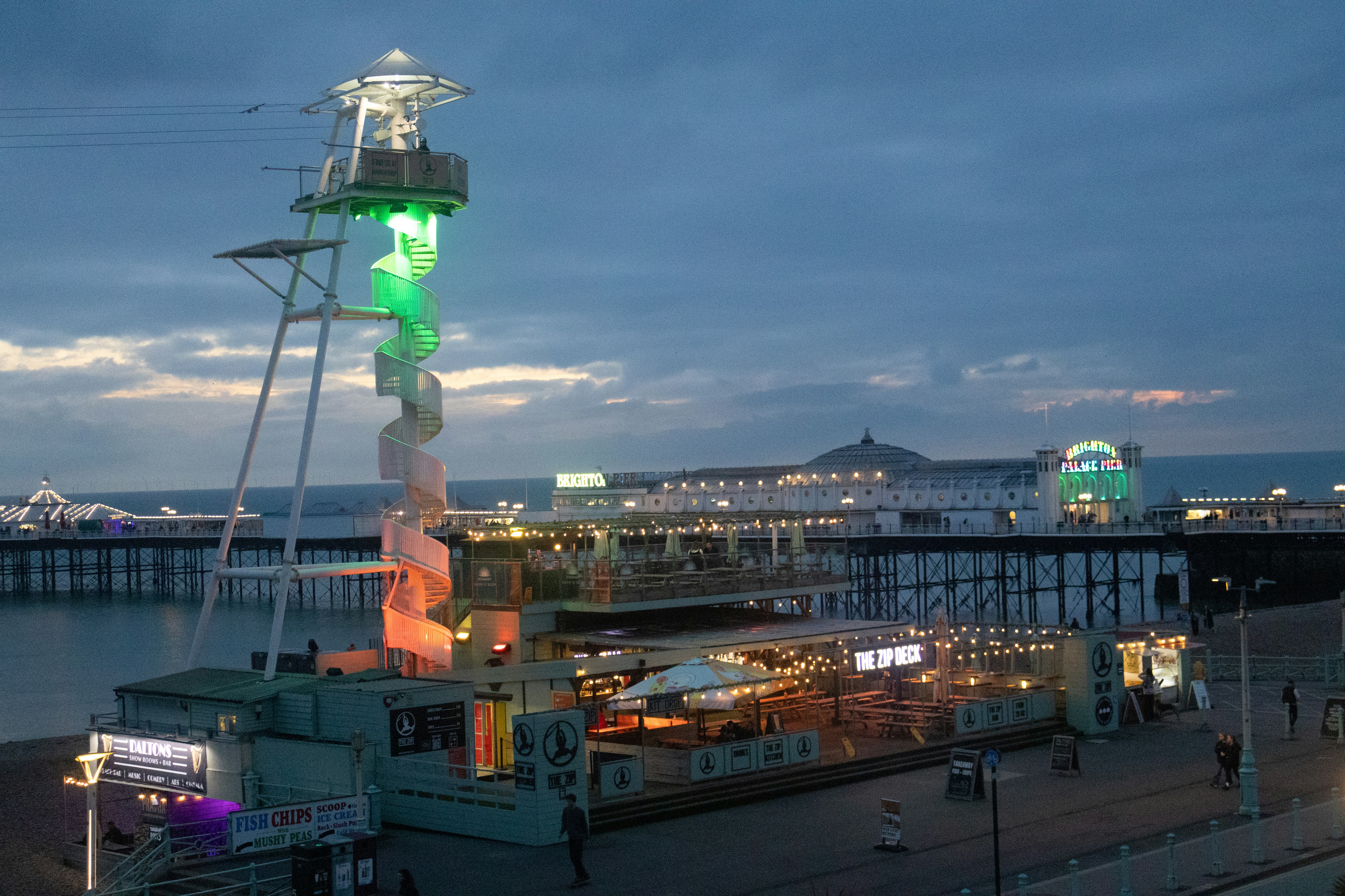Spiral Neon Tower Brightens a Dusk Pier
