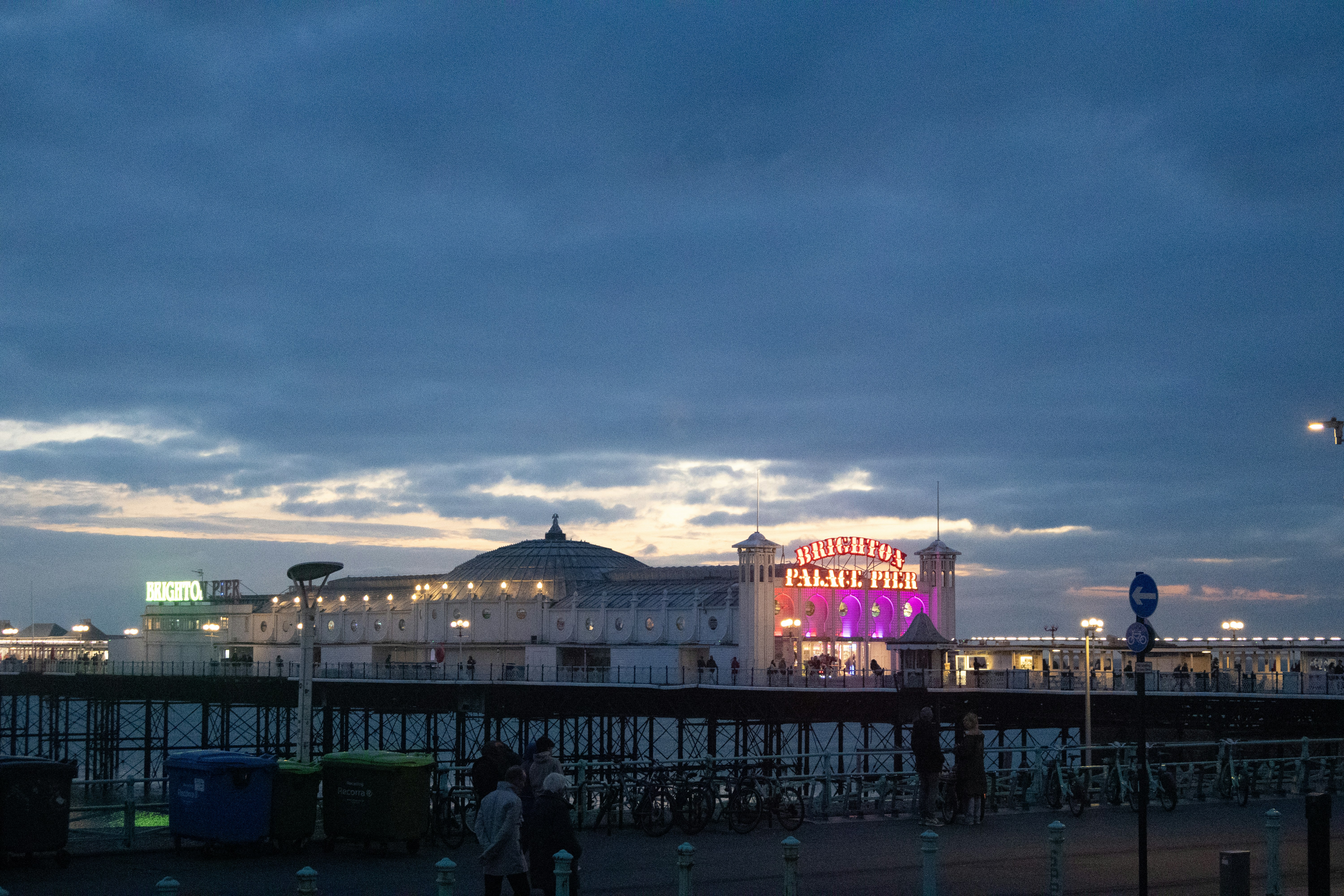 Neon Promenade at Dusk: Pierfront Glow Over Calm Waters