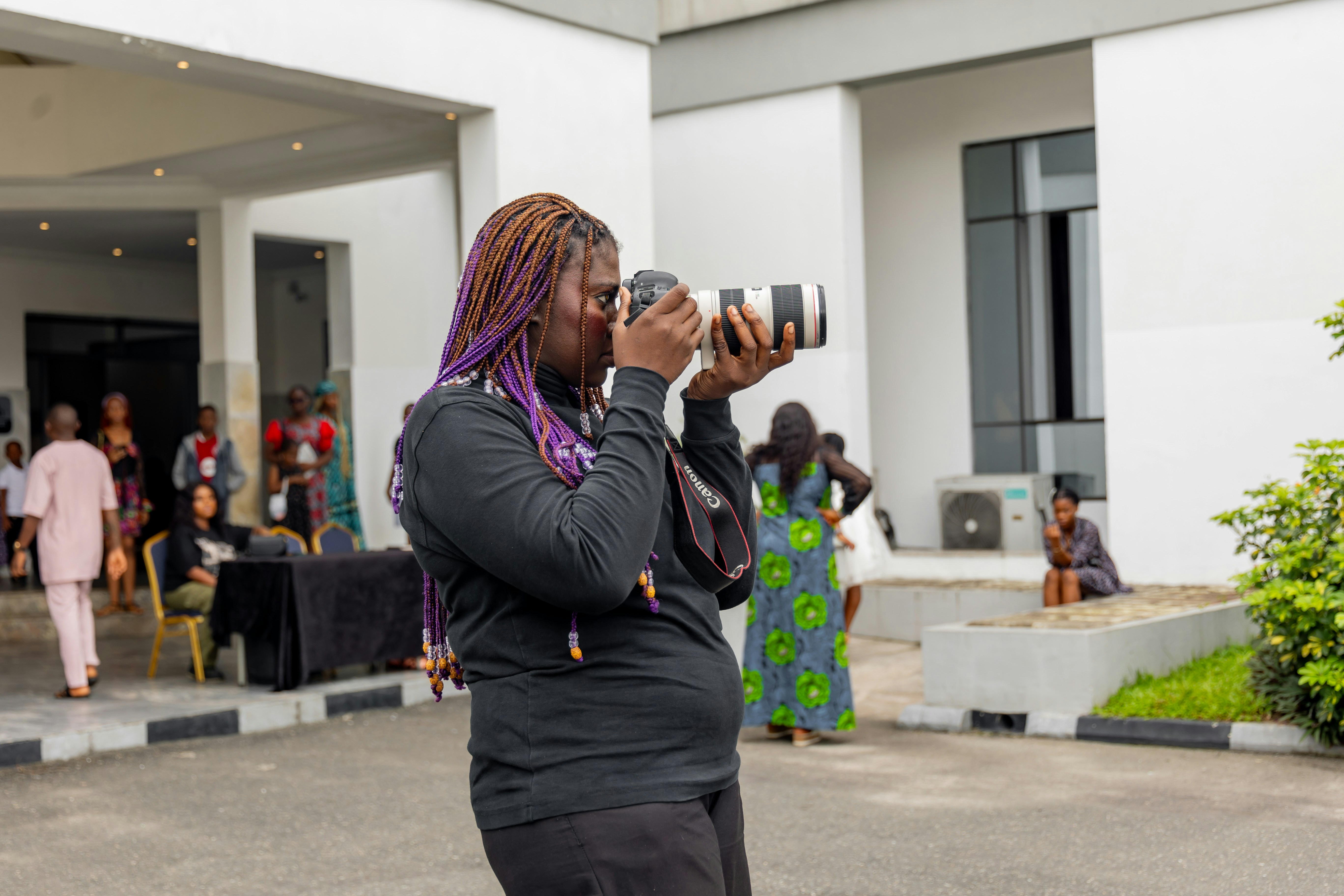 Woman with purple braids taking a photo with camera. photo – Free ...