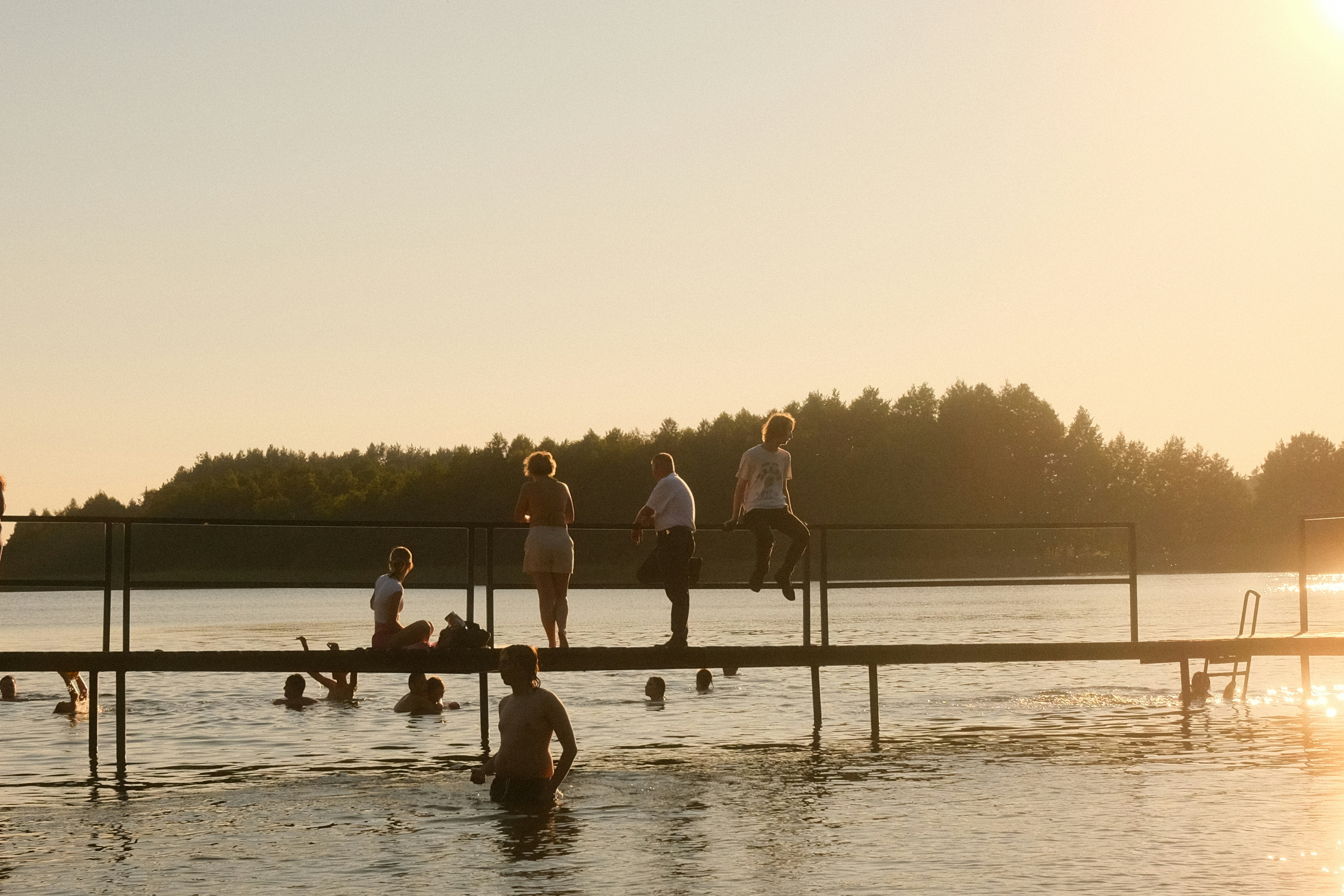 Dusk on the Plank: Lakefront Silhouettes at Sunset