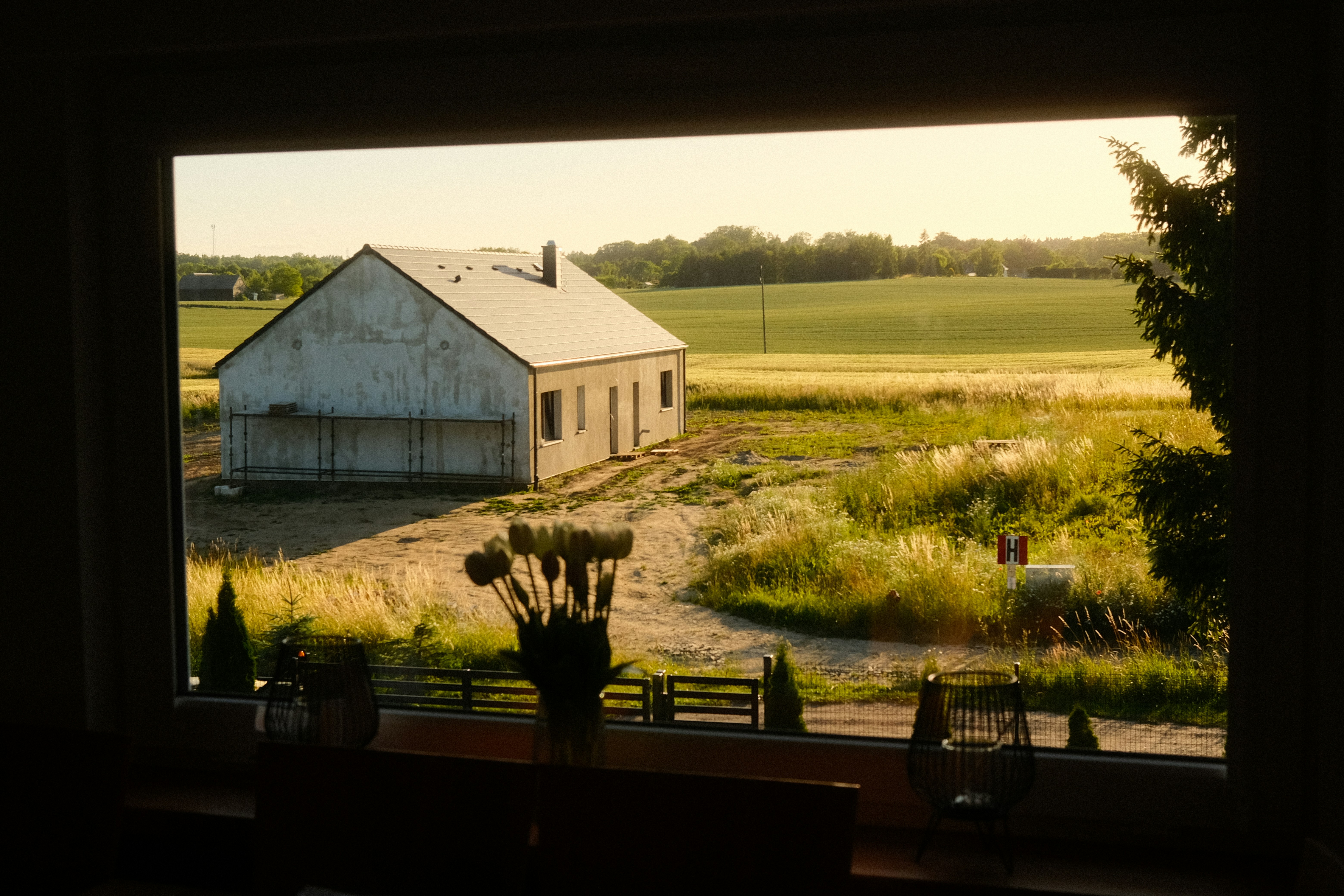 Golden Window View: Weathered Barn in Quiet Afternoon Light