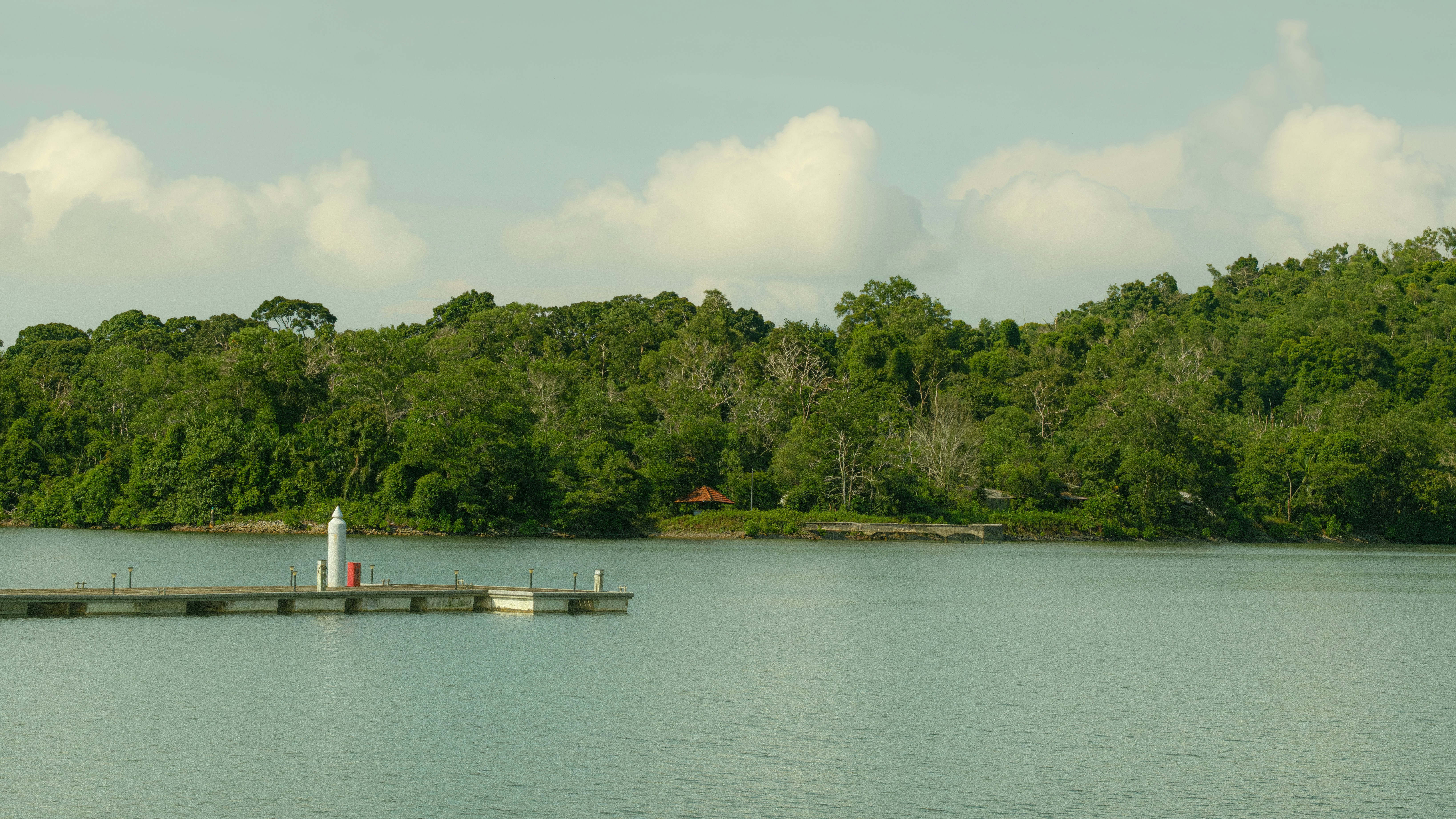 Lighthouse at the Quiet Pier by a Serene Lakeshore