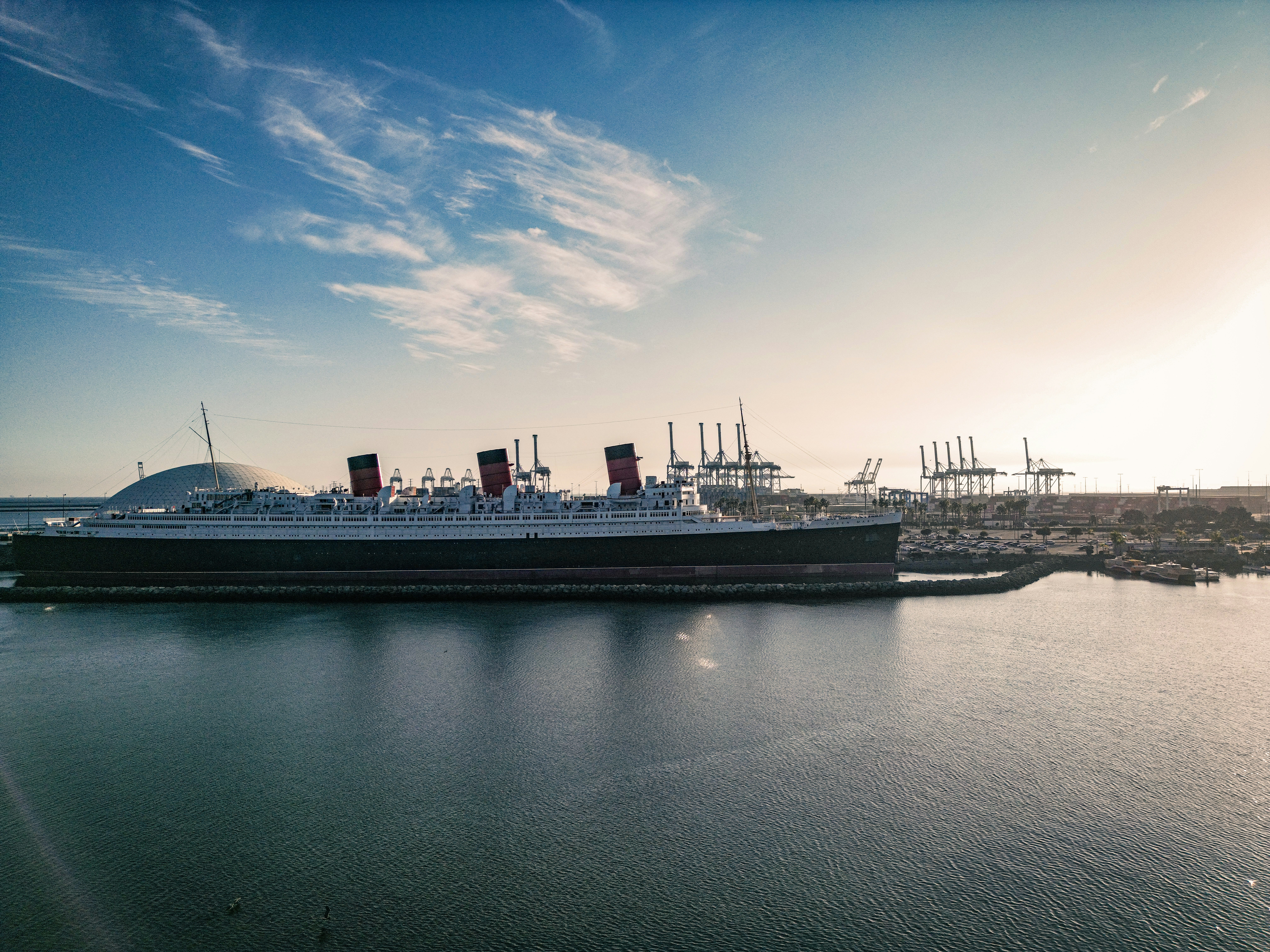 Dawn at the Docks: A Quiet Ocean Liner Resting Along a Sunlit Harbor