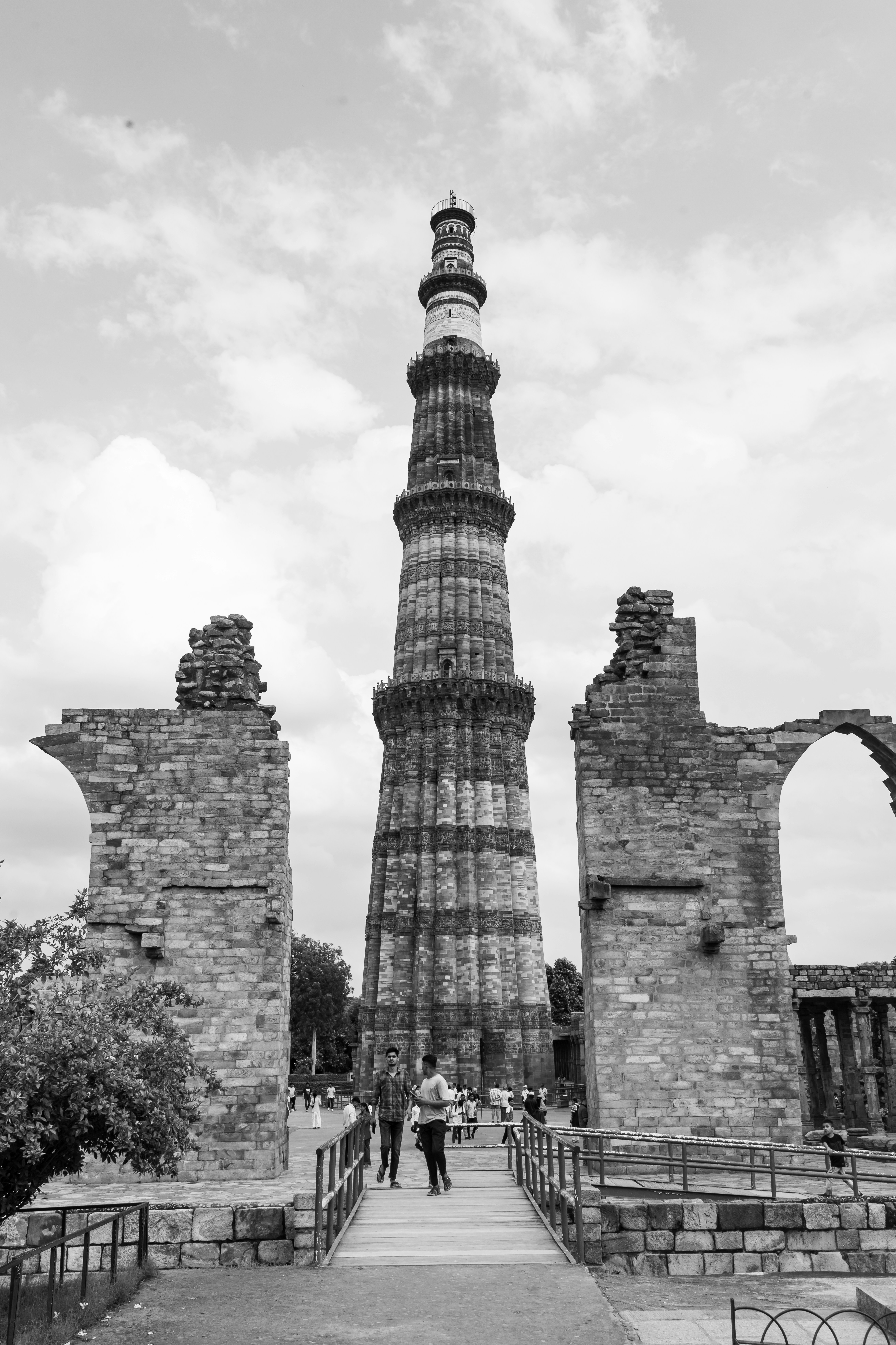 The Silent Sentinel: Qutub’s Tower through Ruined Gates