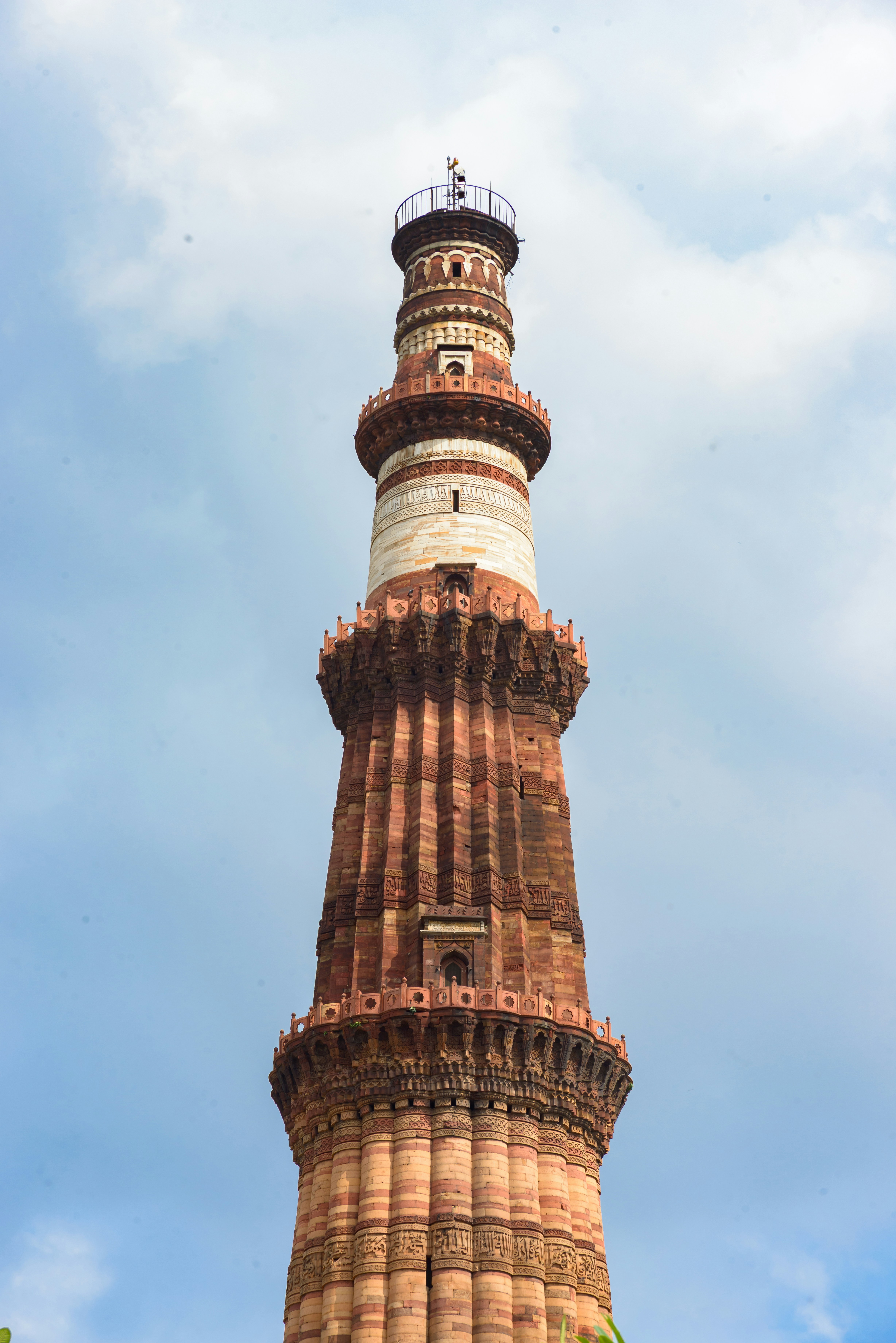 Rising Rings: A Bricked Minaret Carved in Time Against a Clear Sky