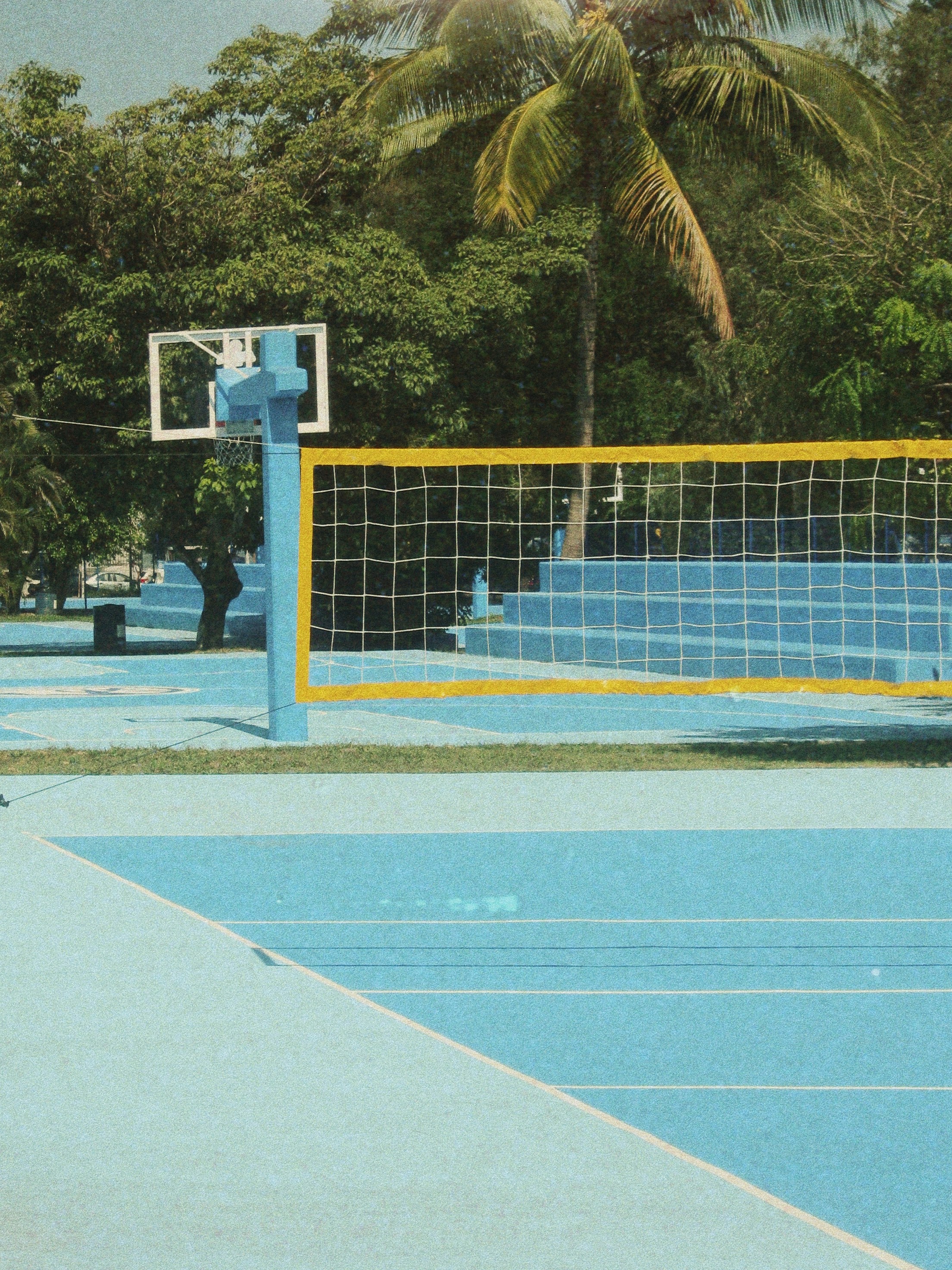 Outdoor basketball court with volleyball net