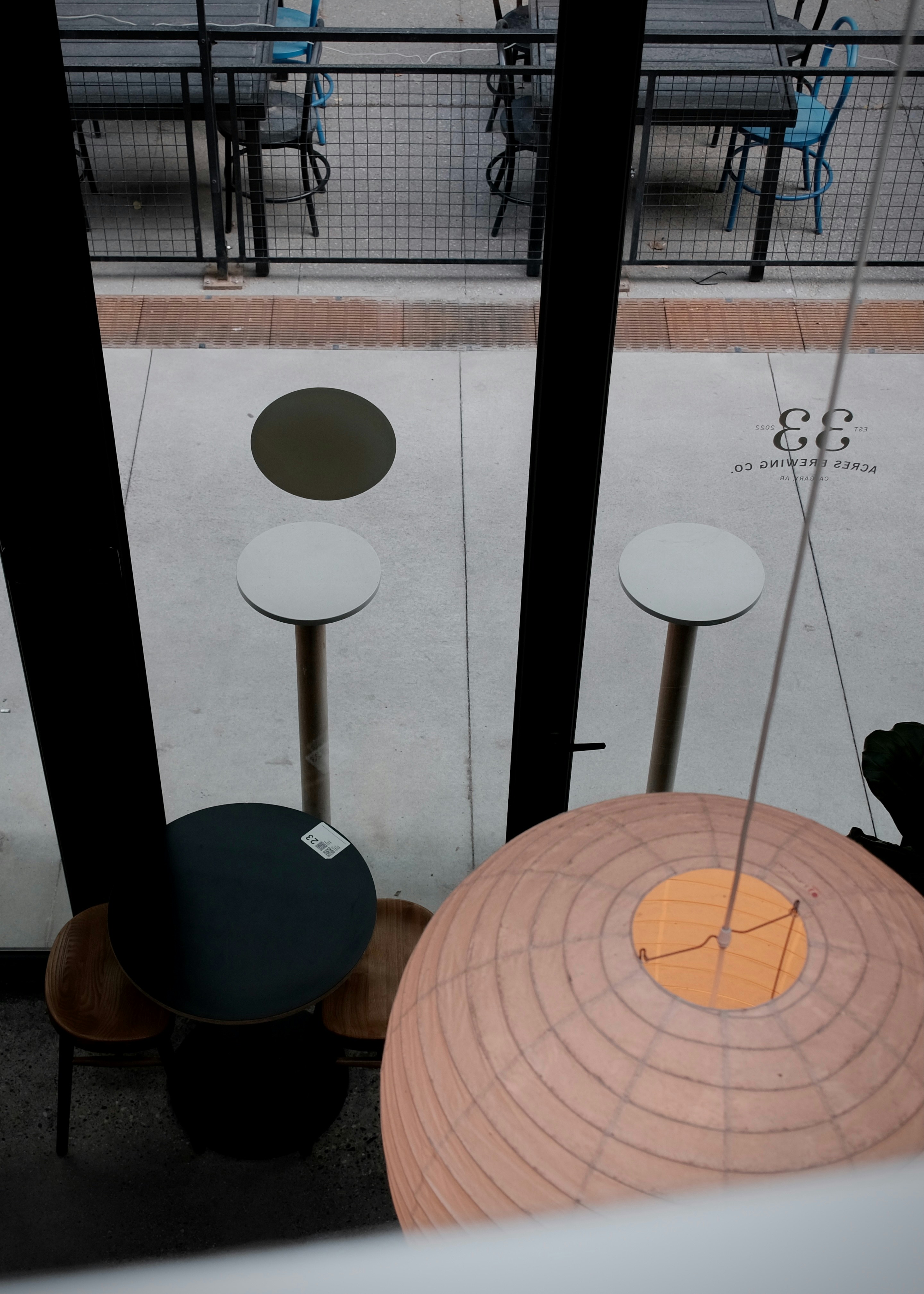 Outdoor cafe tables and chairs seen from above.