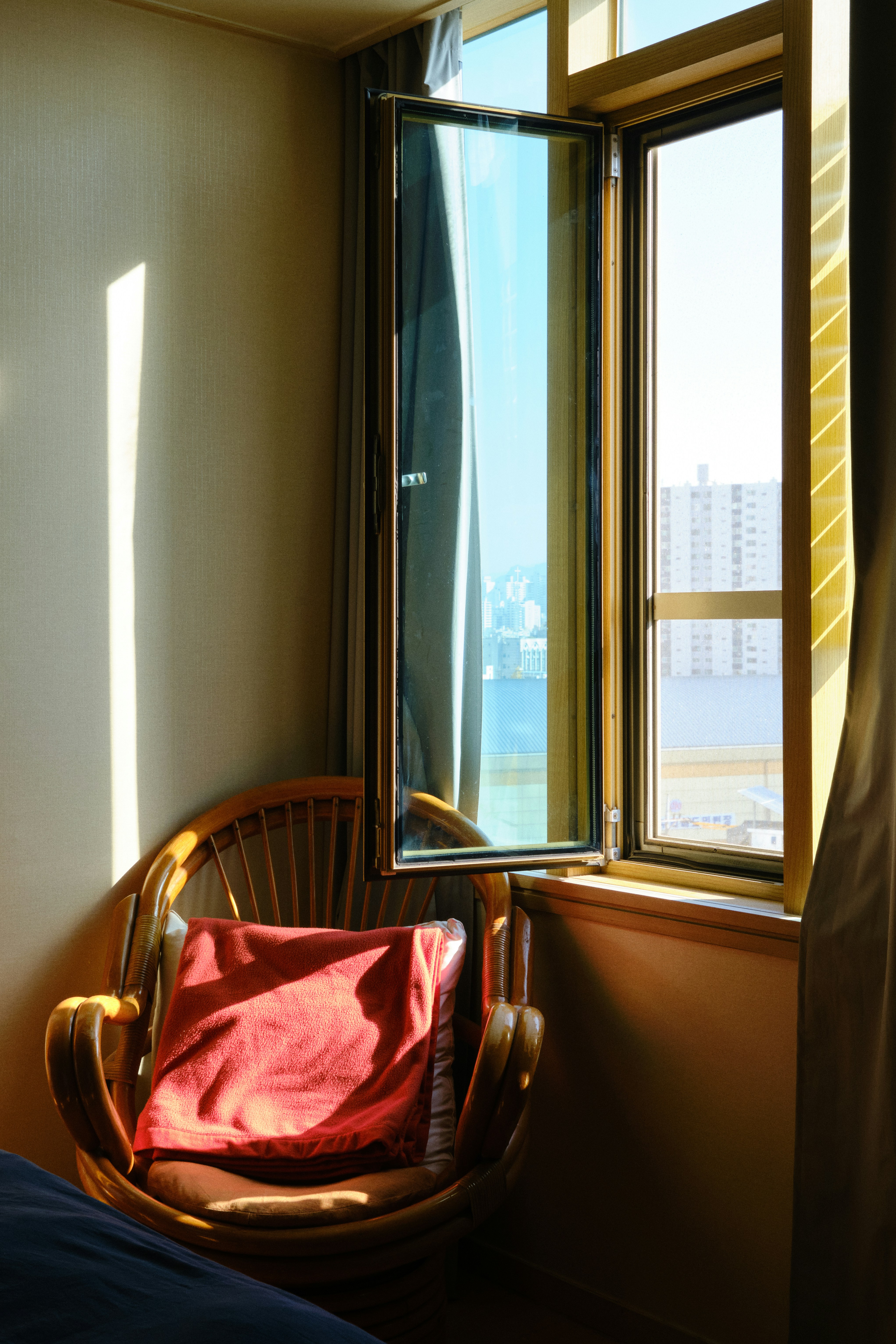 An indoor chair near a windows at sunset