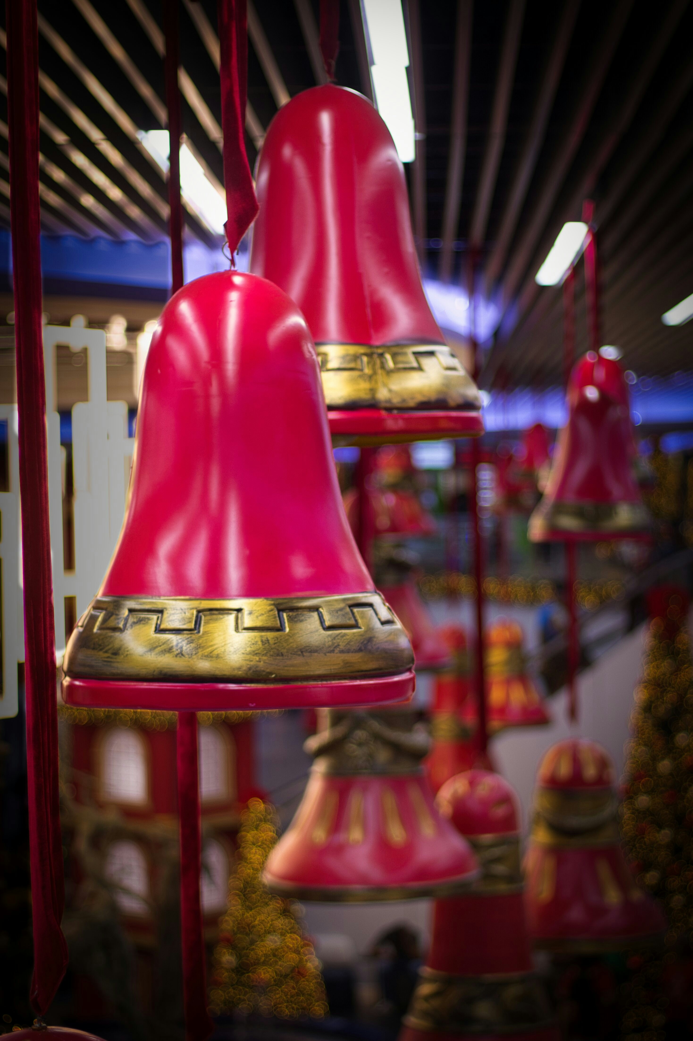 Crimson Bell Close-Up: Velvet Red in a Festive Aisle