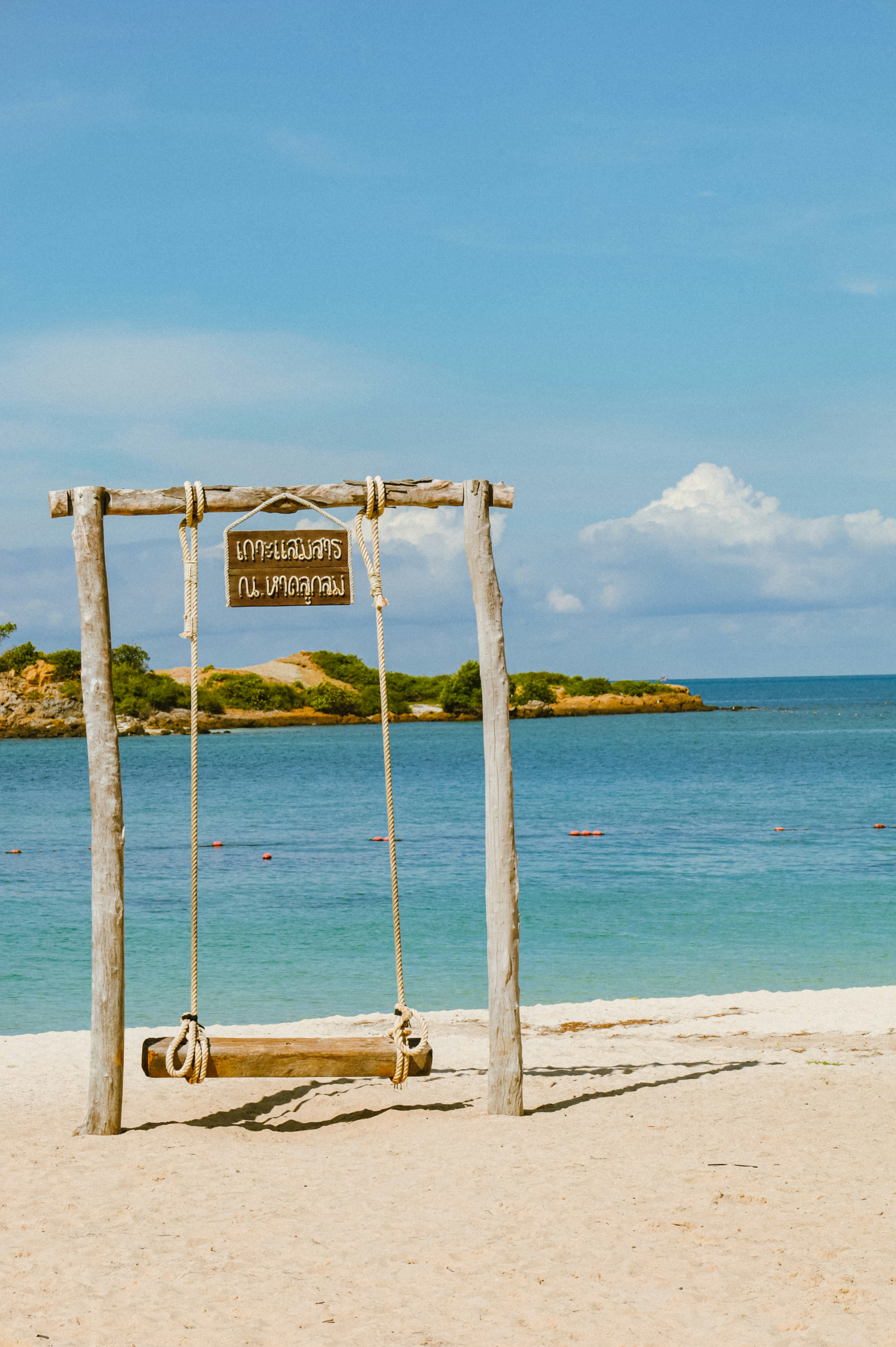 Weathered Swing on a Turquoise Beach: A Quiet Thai Shoreline Moment