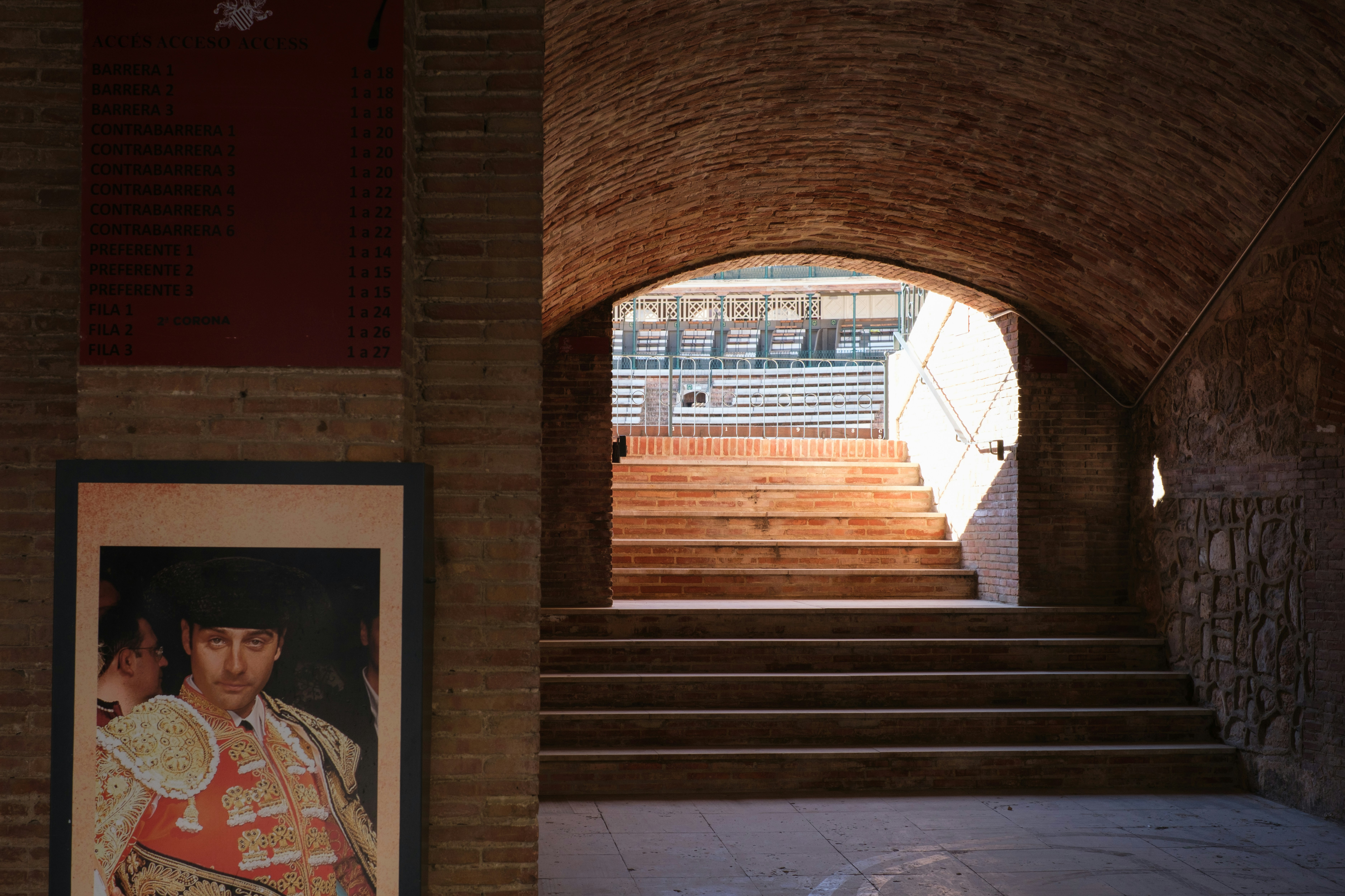 Exit in Light: A brick arch frames a sunlit stairway