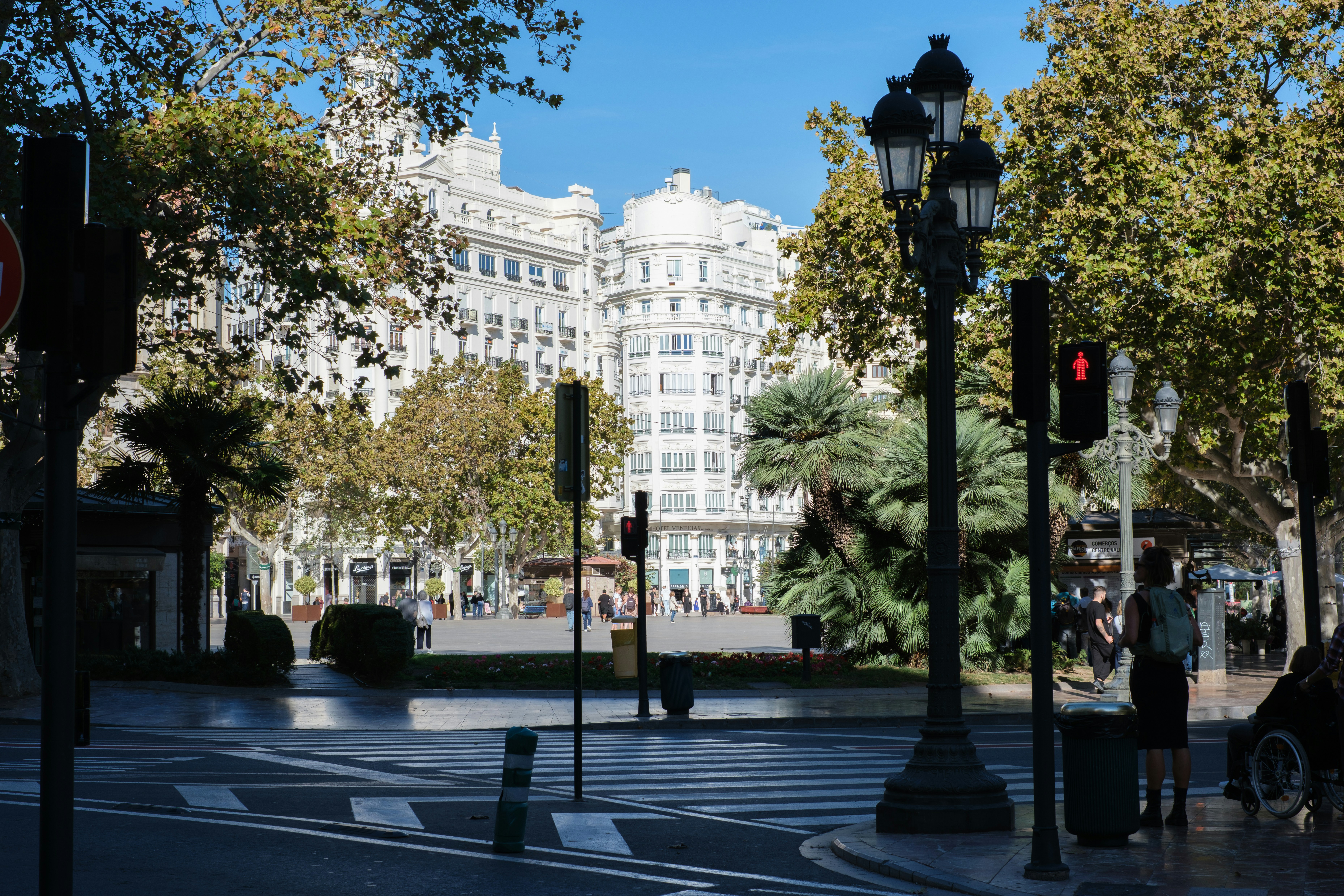 Sunlit Neoclassical Facade Rising Over a Quiet Urban Crossing
