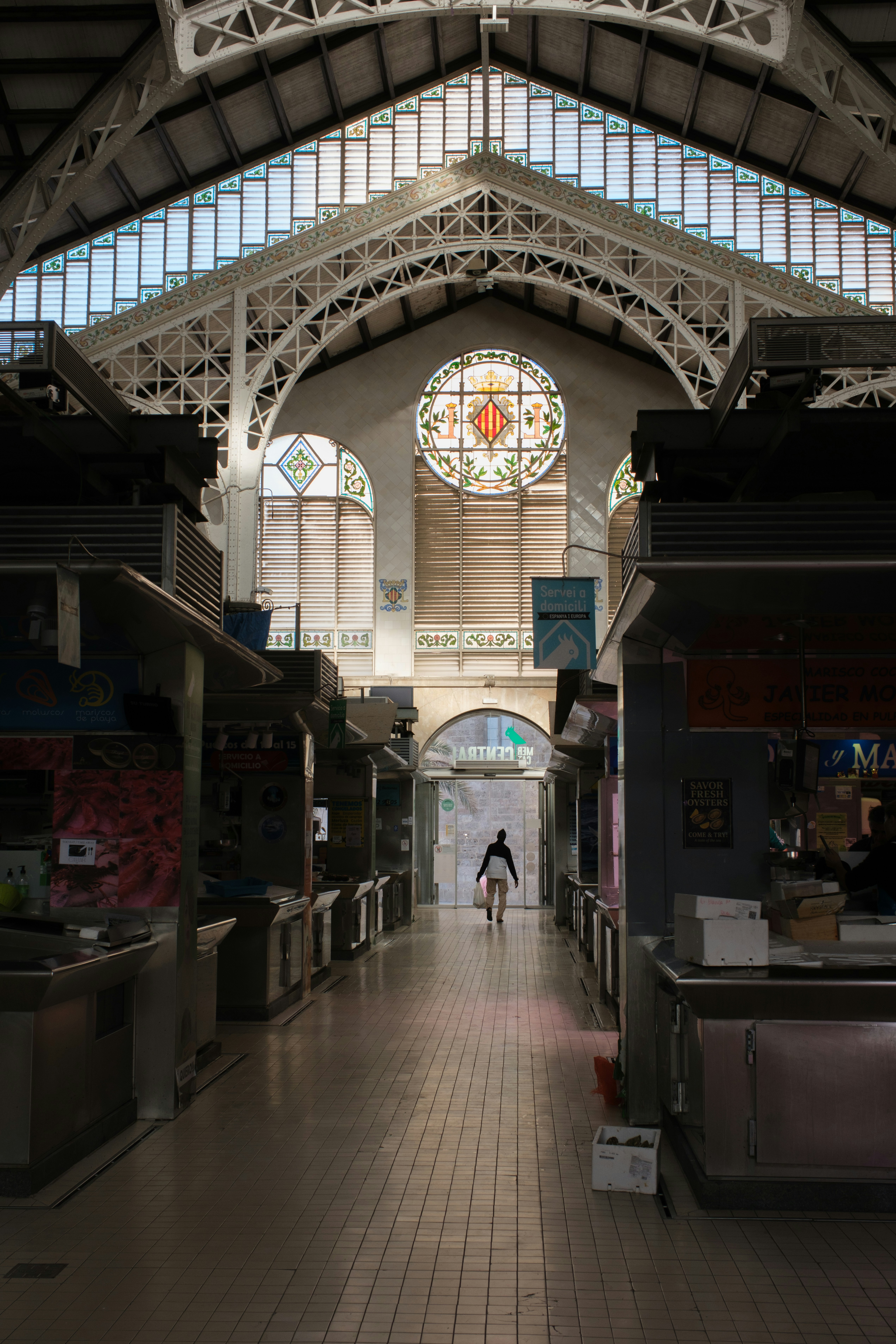 Market Cathedral: A Lone Traveler Beneath Stained-Glass Arches