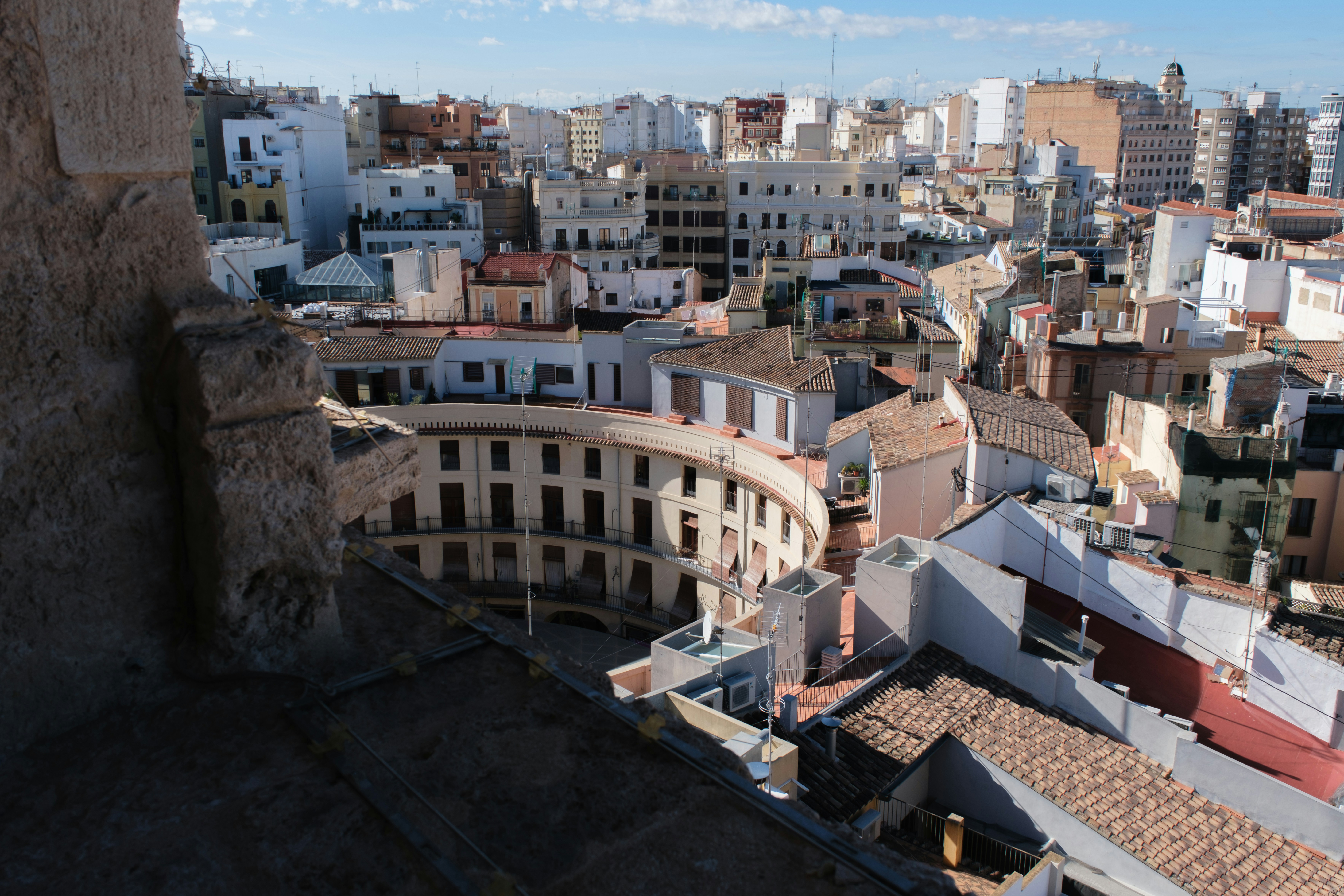 Circular Courtyard Looms Over a Sea of Terracotta Rooftops