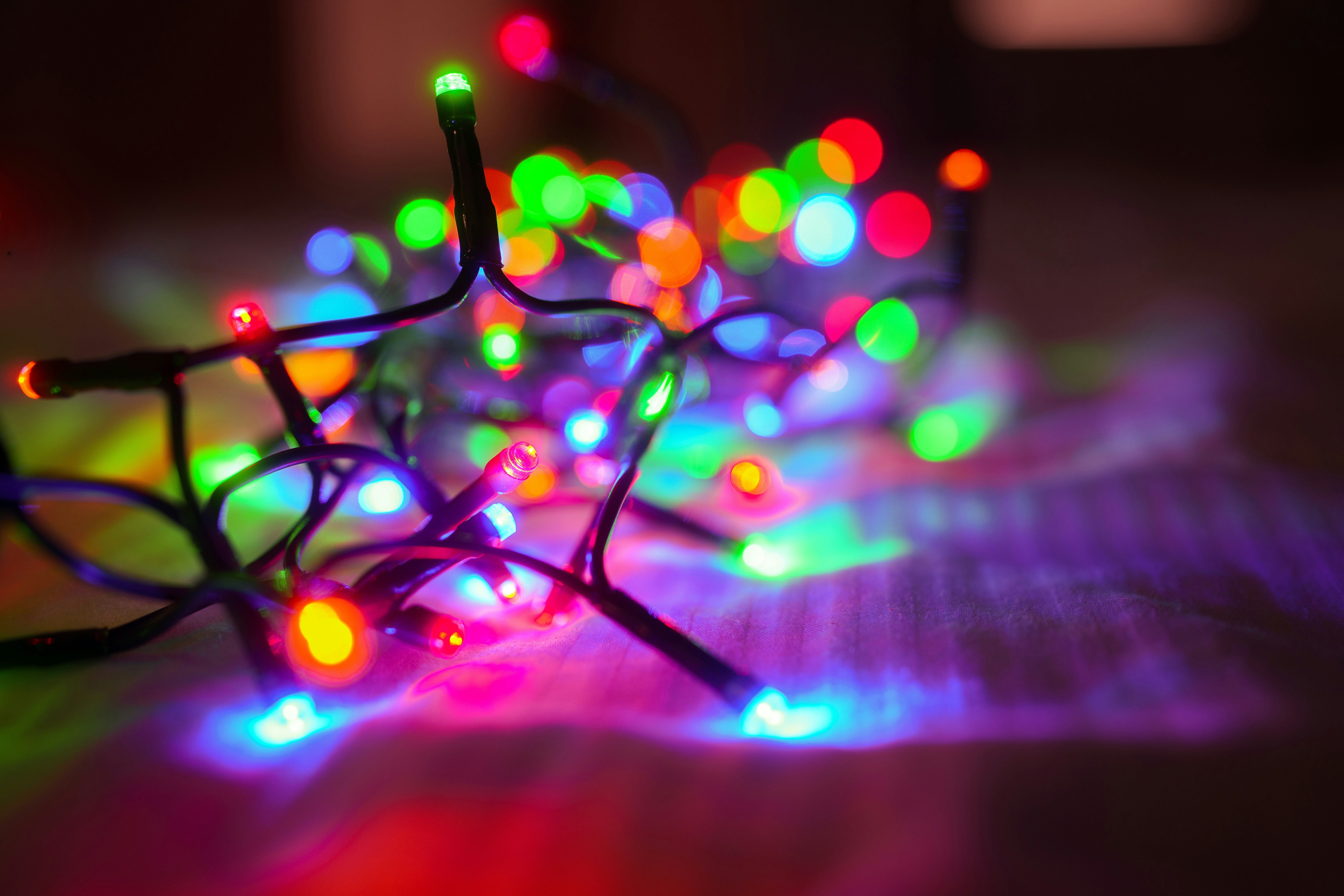 Neon Thread on a Quiet Surface: A Close-Up of Multicolored Holiday Lights